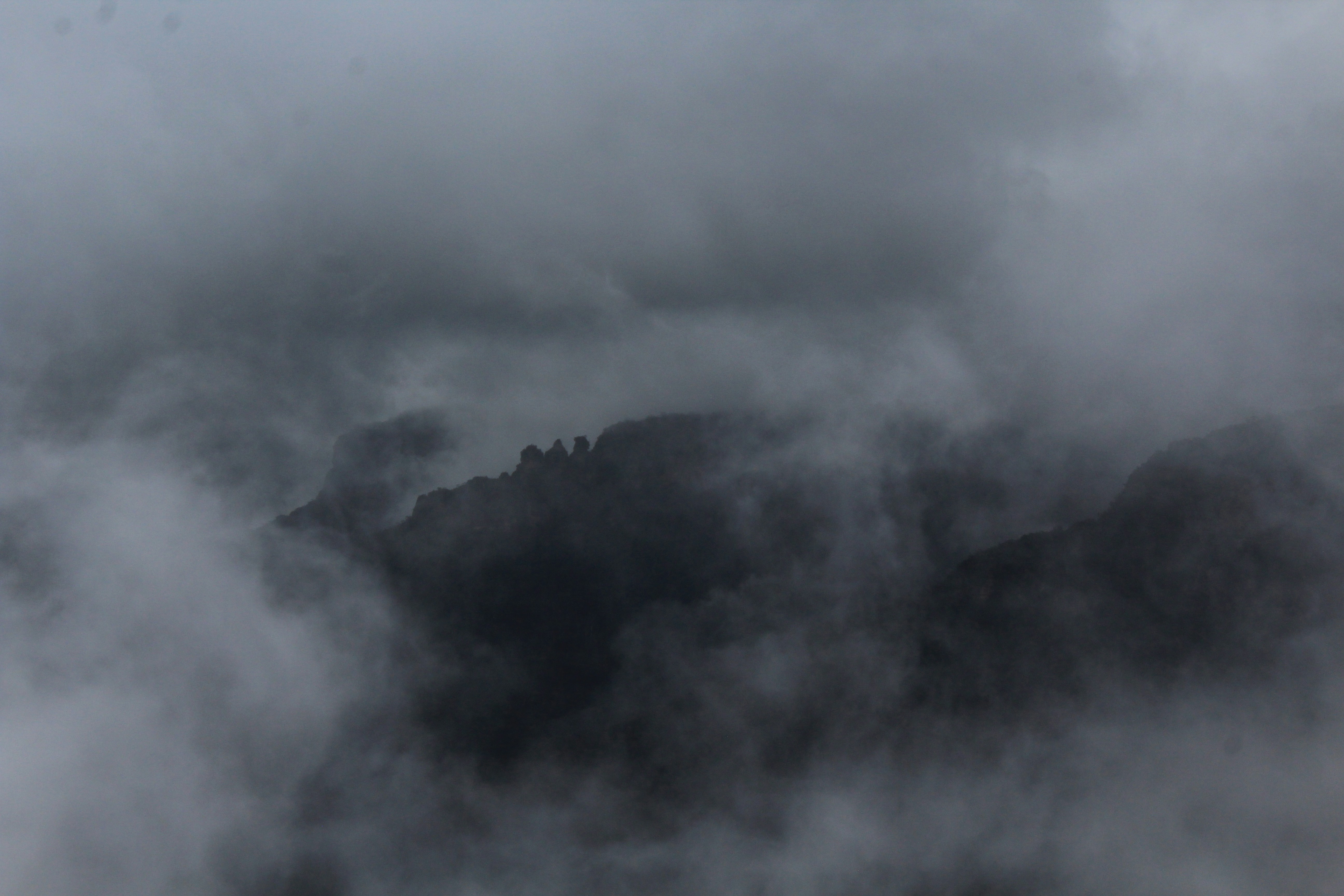 Fog-shrouded ridge in subdued mountain silhouette