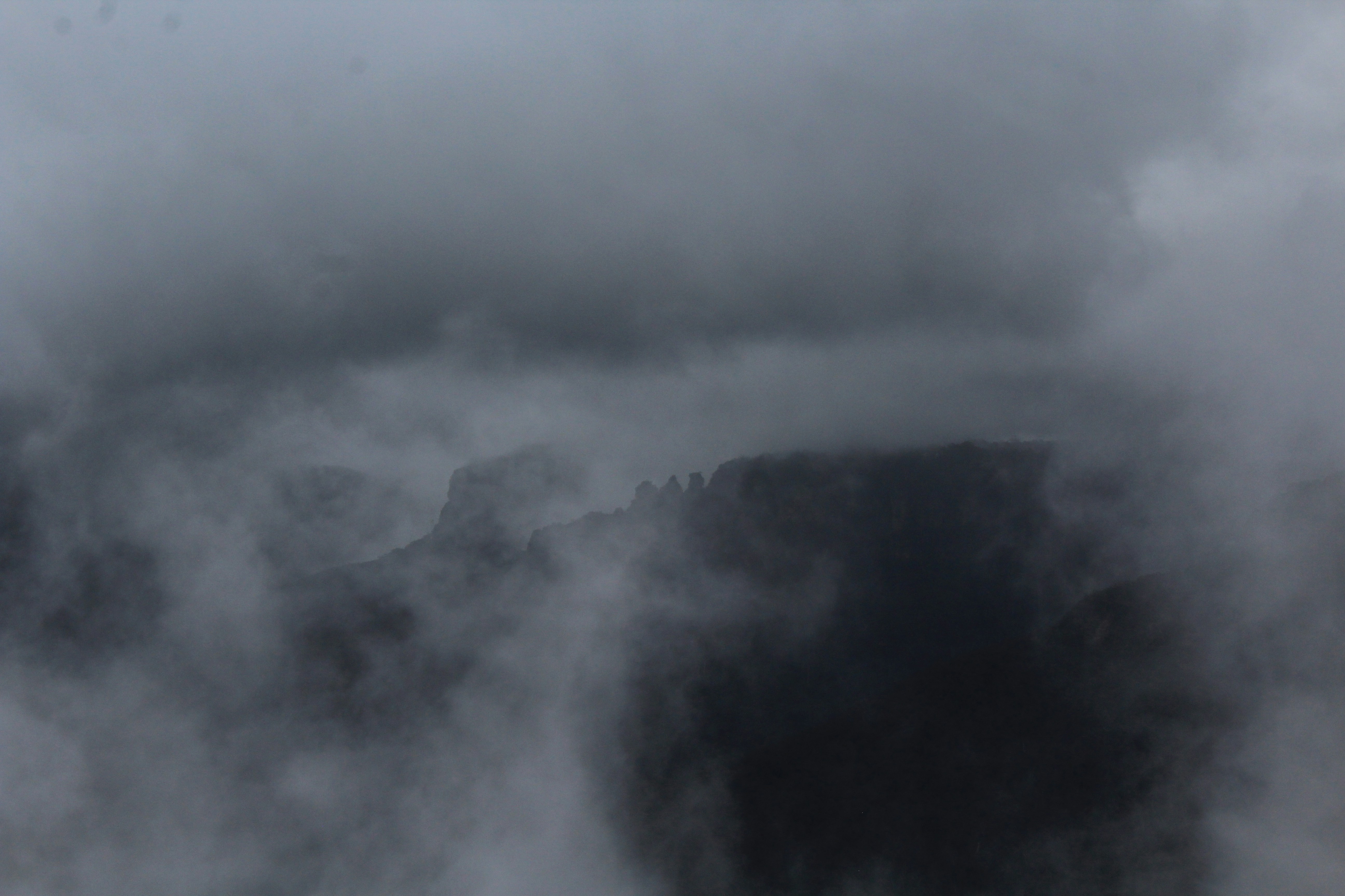 Veiled Edge: Cliffs Bleeding into Morning Mist