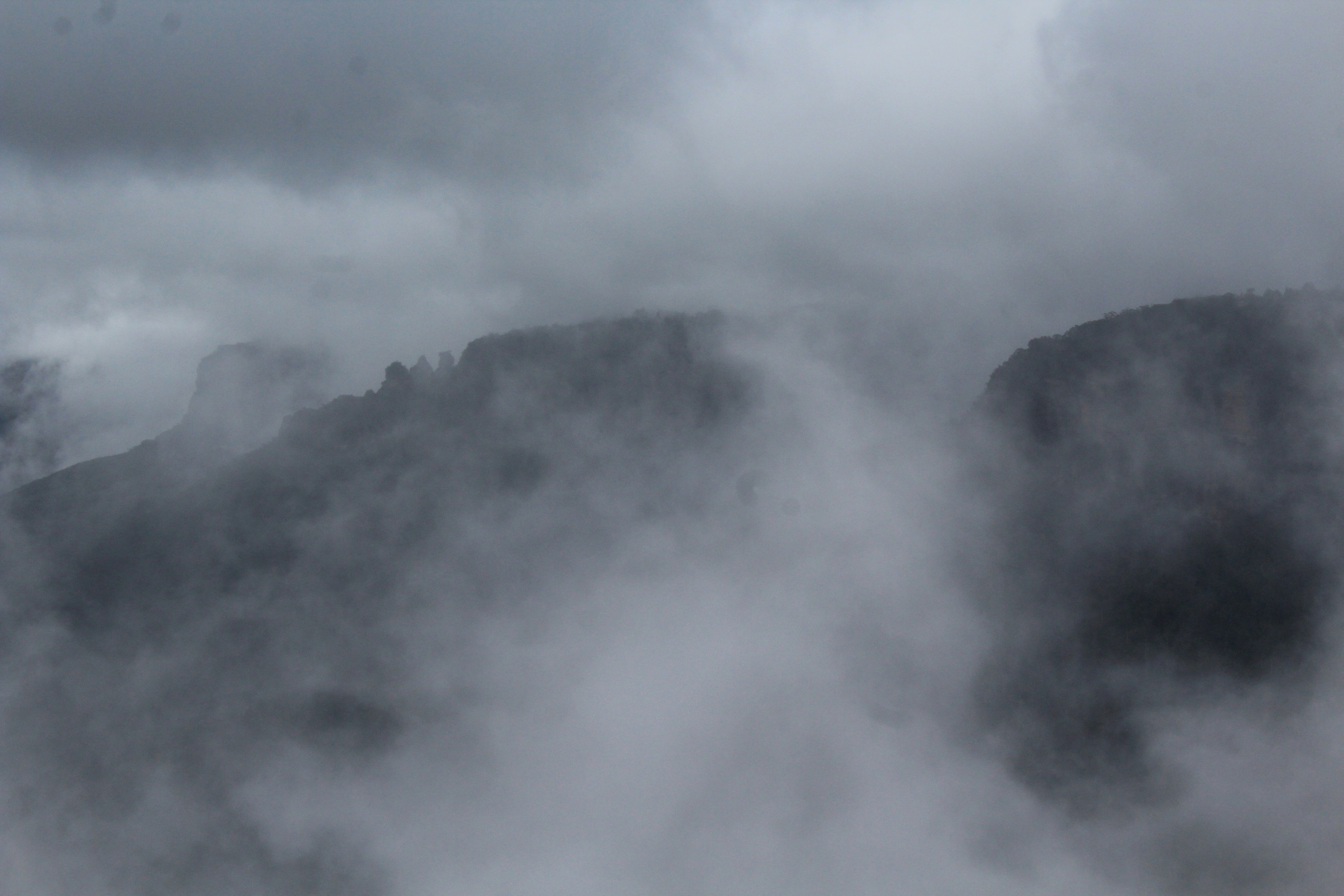 Misty Crest: Peaks Emerging Through the Cloud Veil