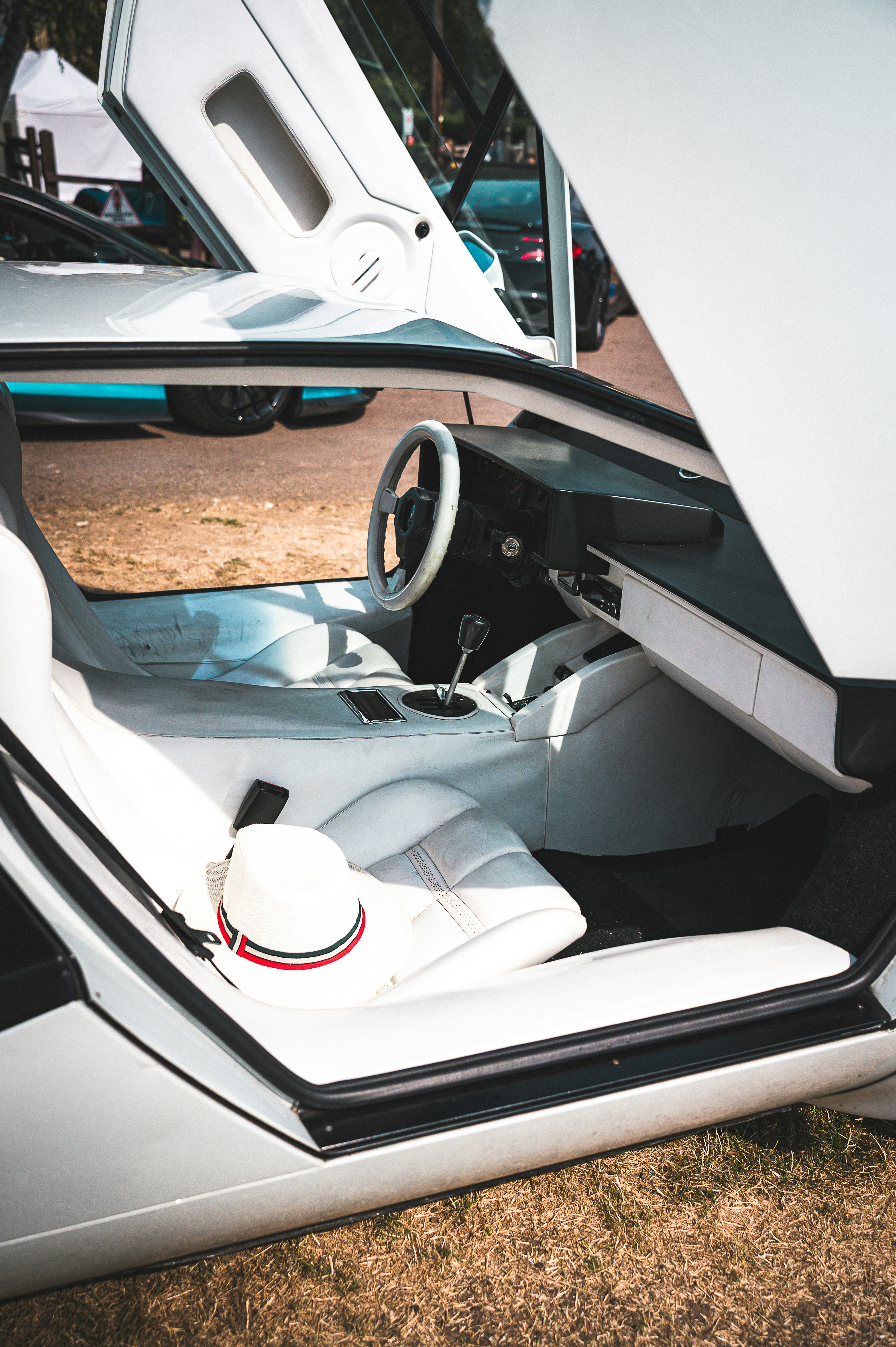 White Exotic: The Open Door Revealing a Minimalist Car Interior