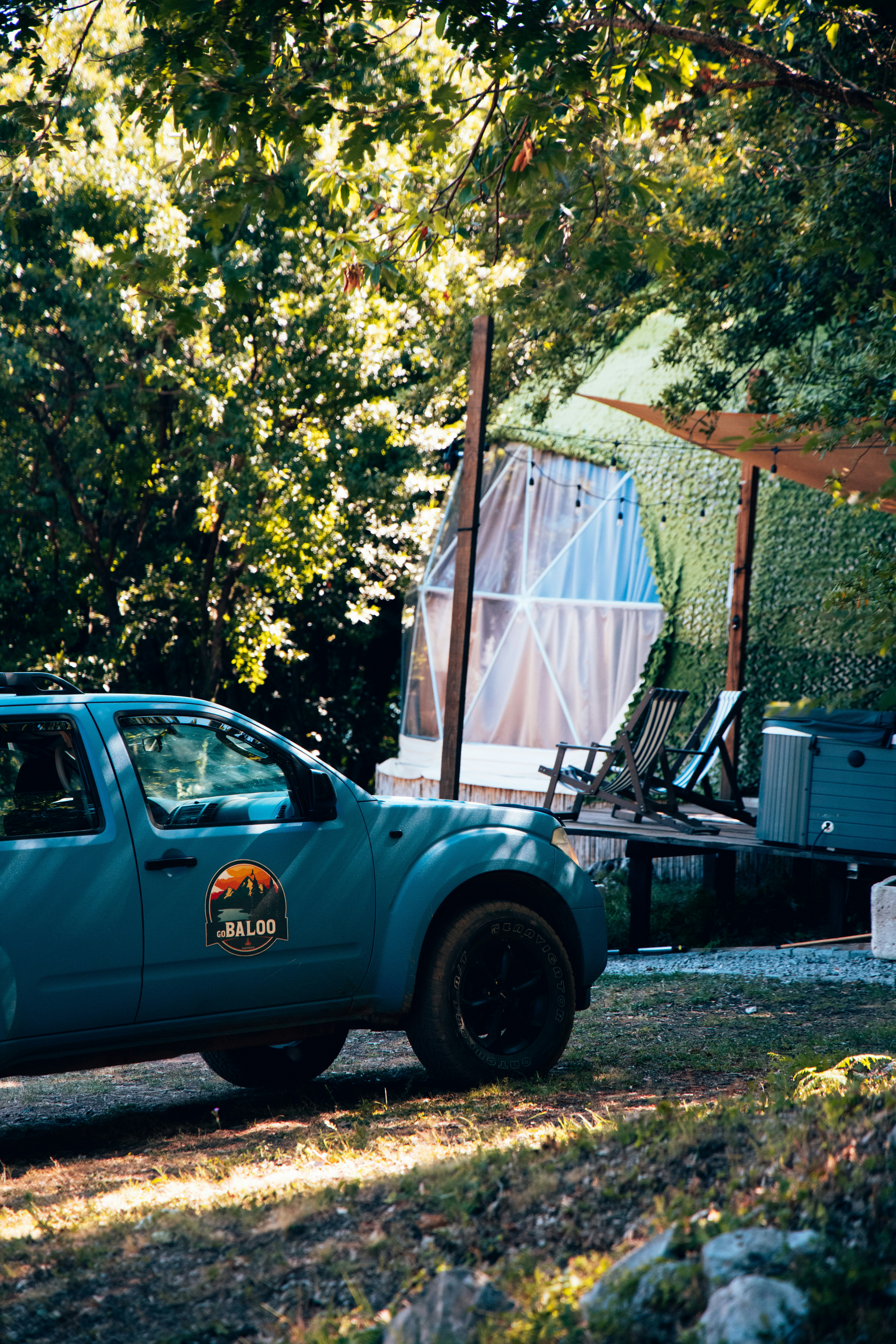 Blue Pickup and Quiet Retreat in Dappled Shade
