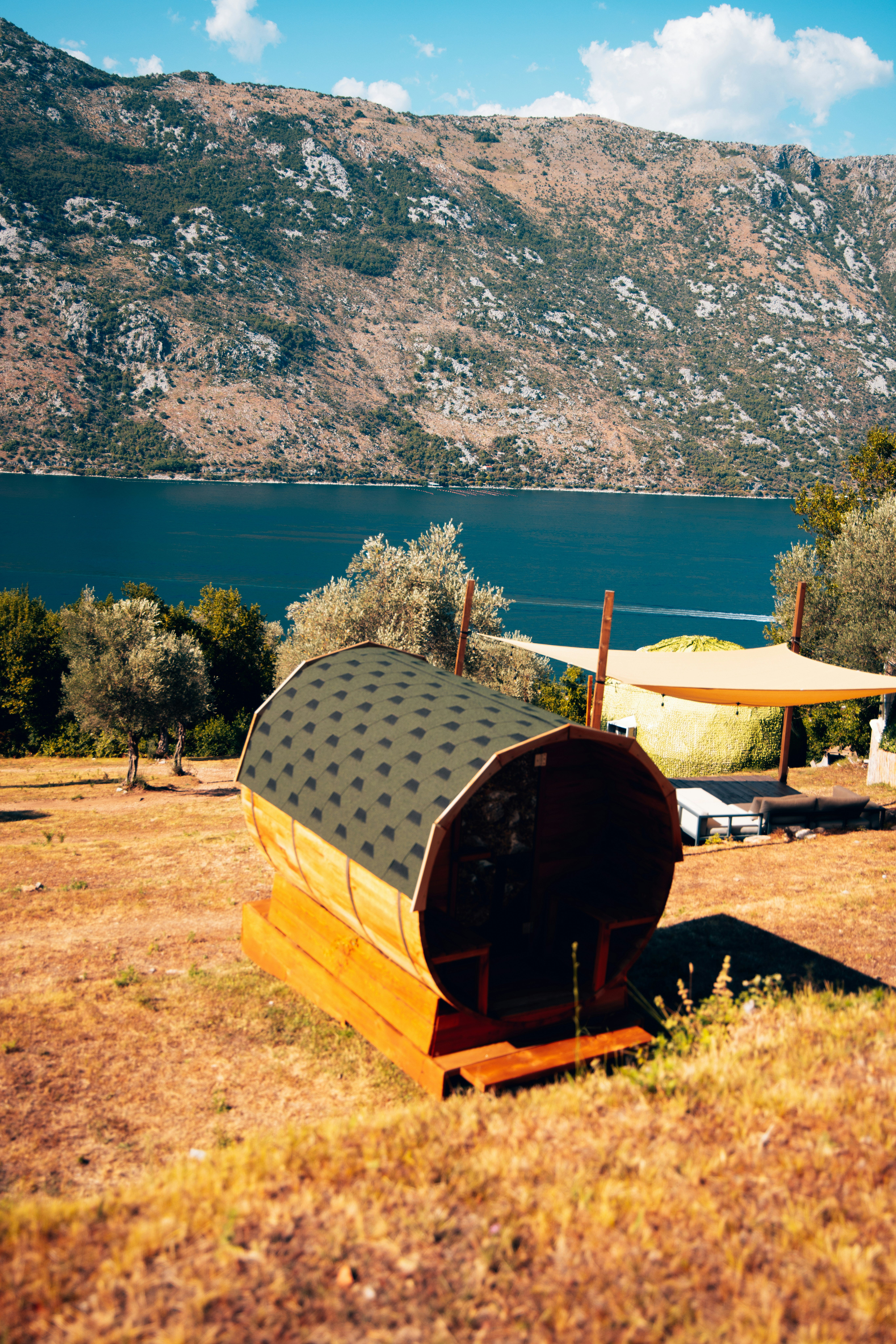 Lakeside Glamping Pod Fringed by Golden Brush and Distant Peaks