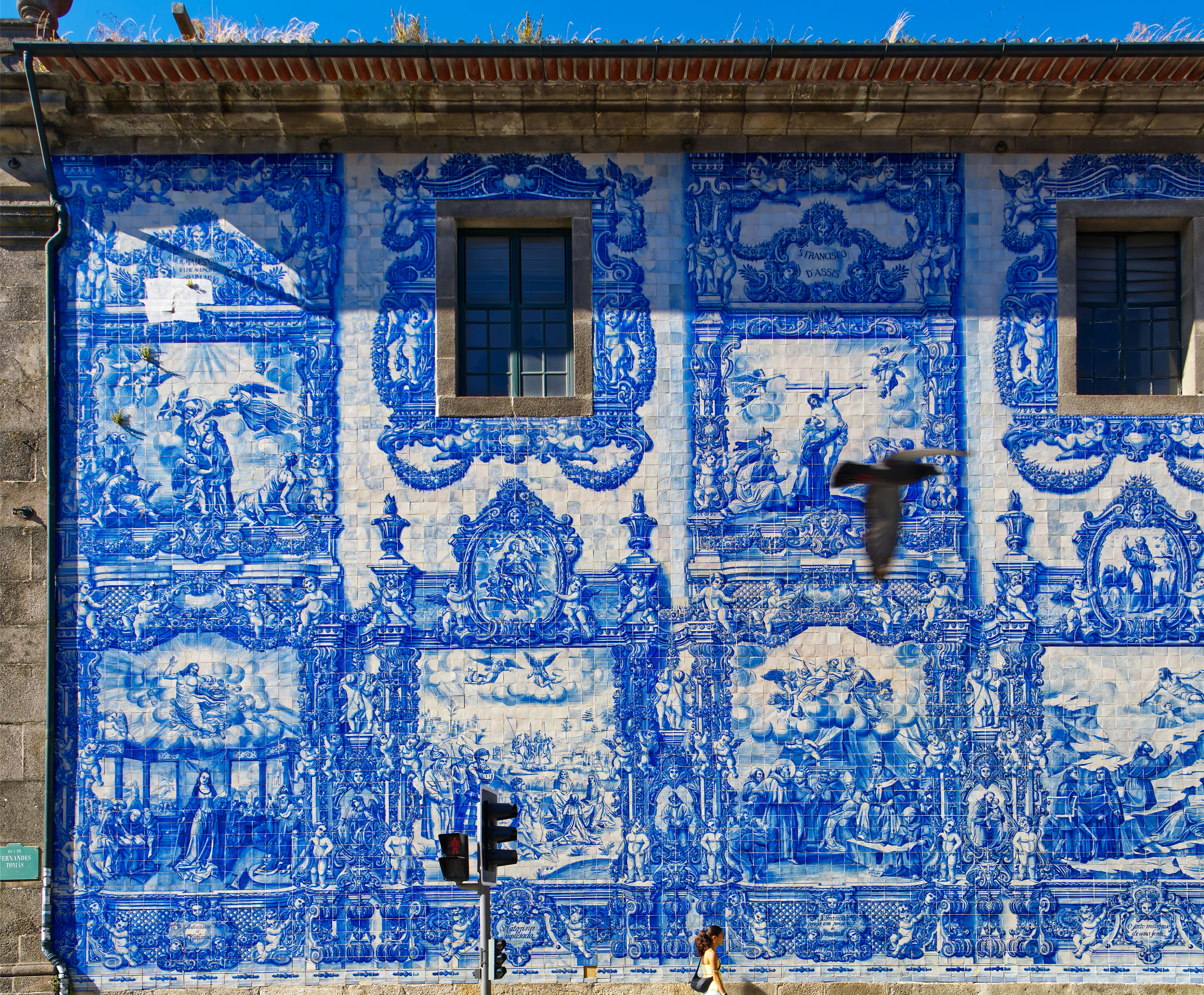 Azure Tiles in Motion: A Framed Window Among Blue Frieze