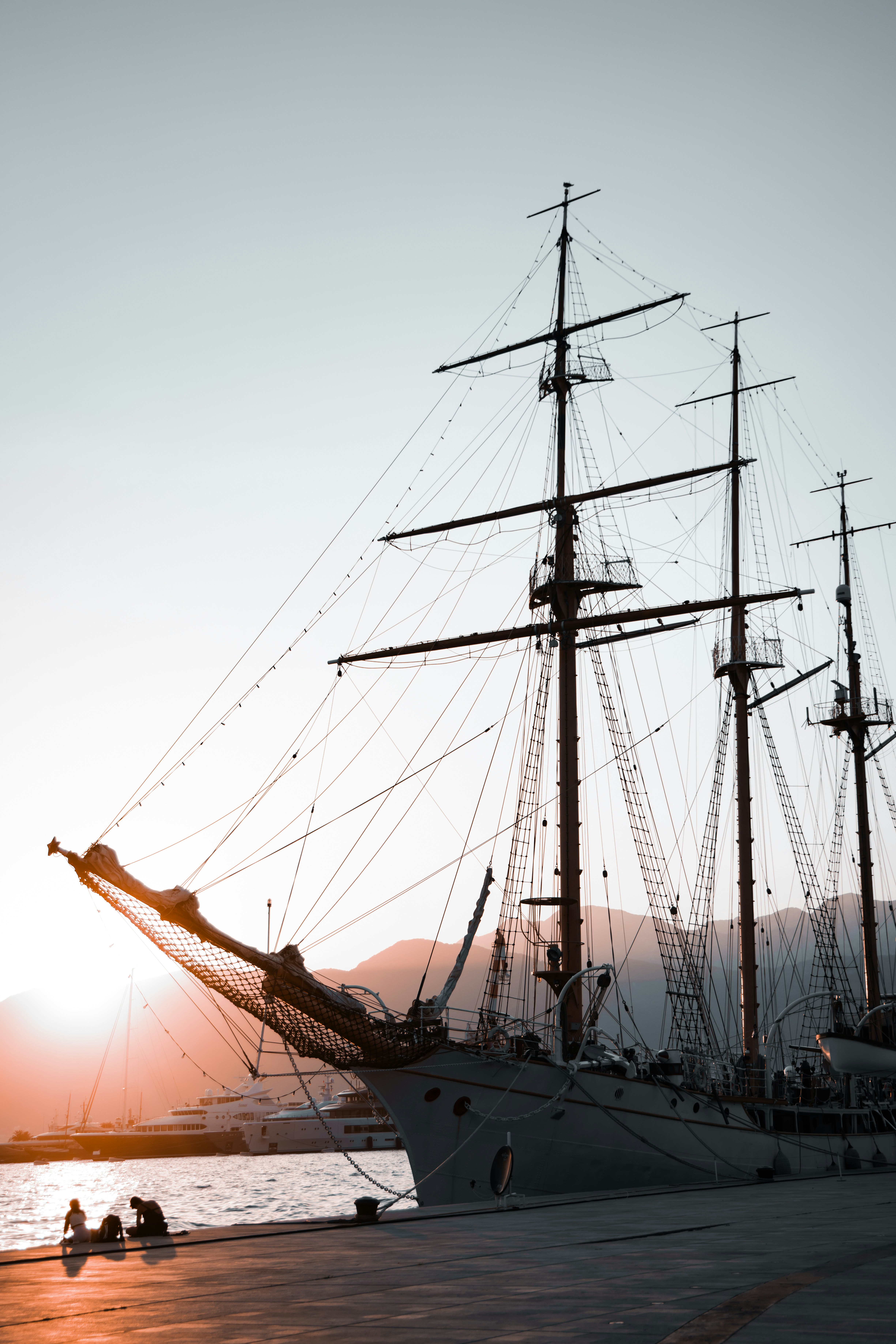 Masts at Dusk: A Harbor Ship silhouette by the Pier