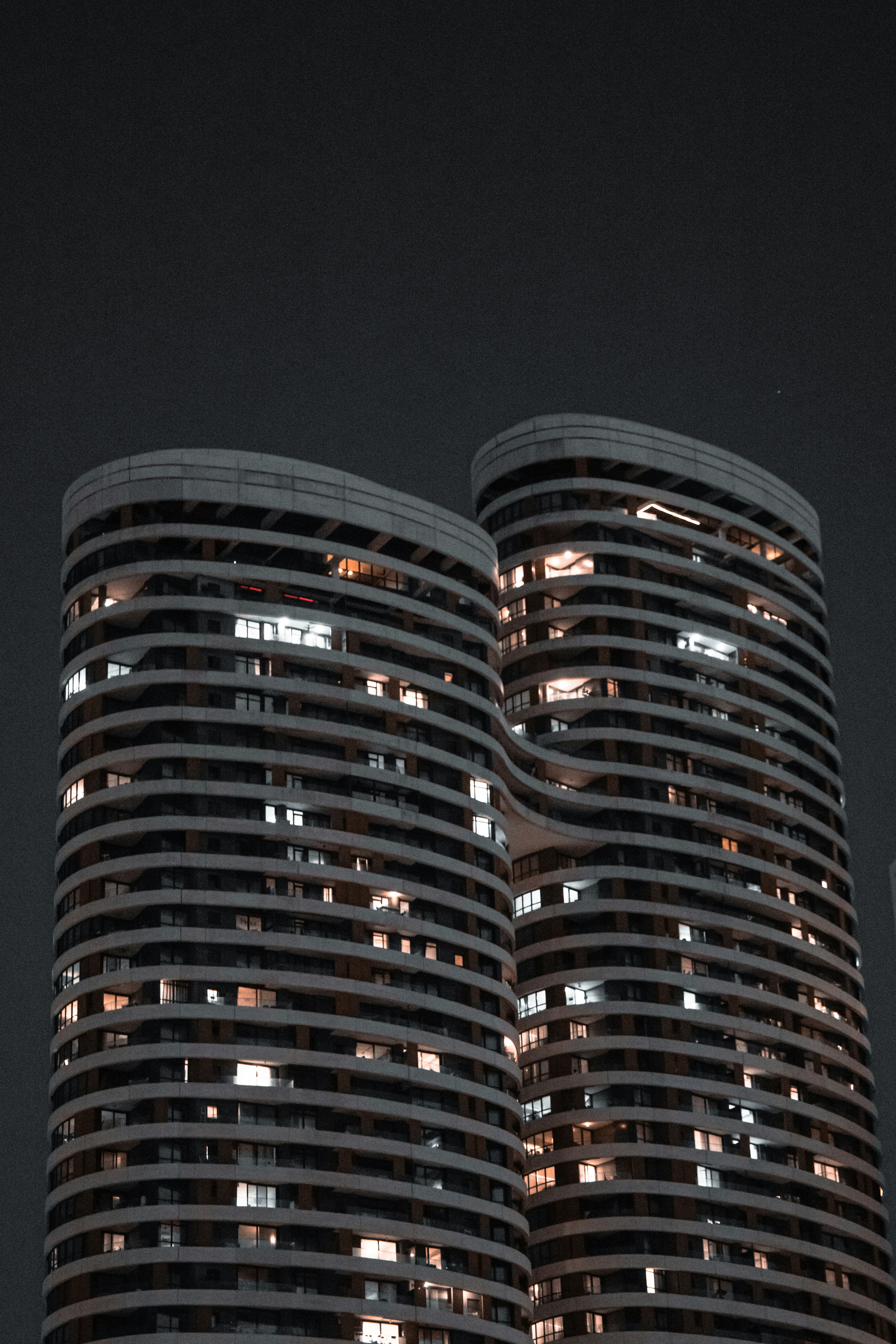 Twin Curves of Night: Illuminated Skyscrapers Piercing the Dark