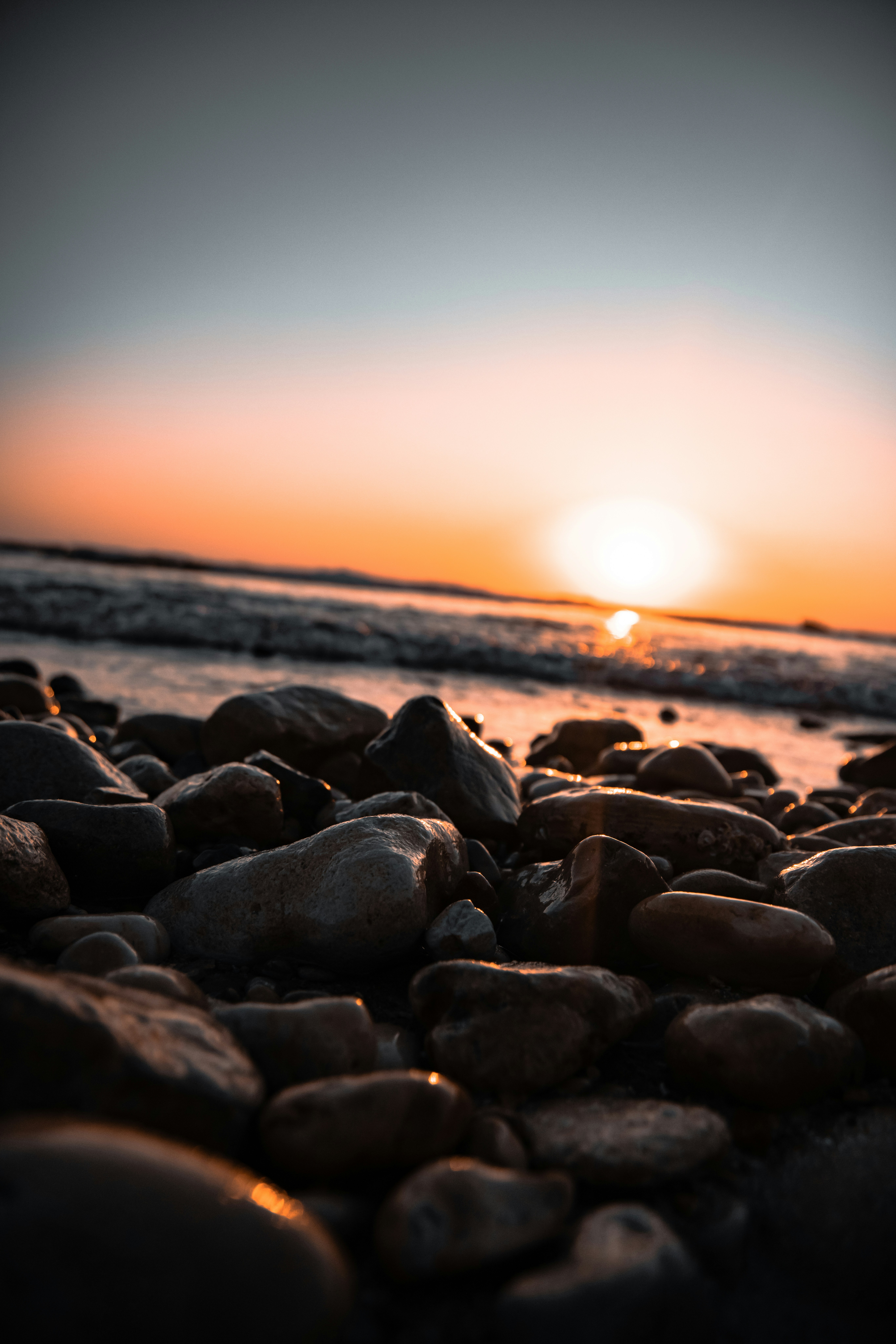 Sunlit pebbles at the edge of the horizon