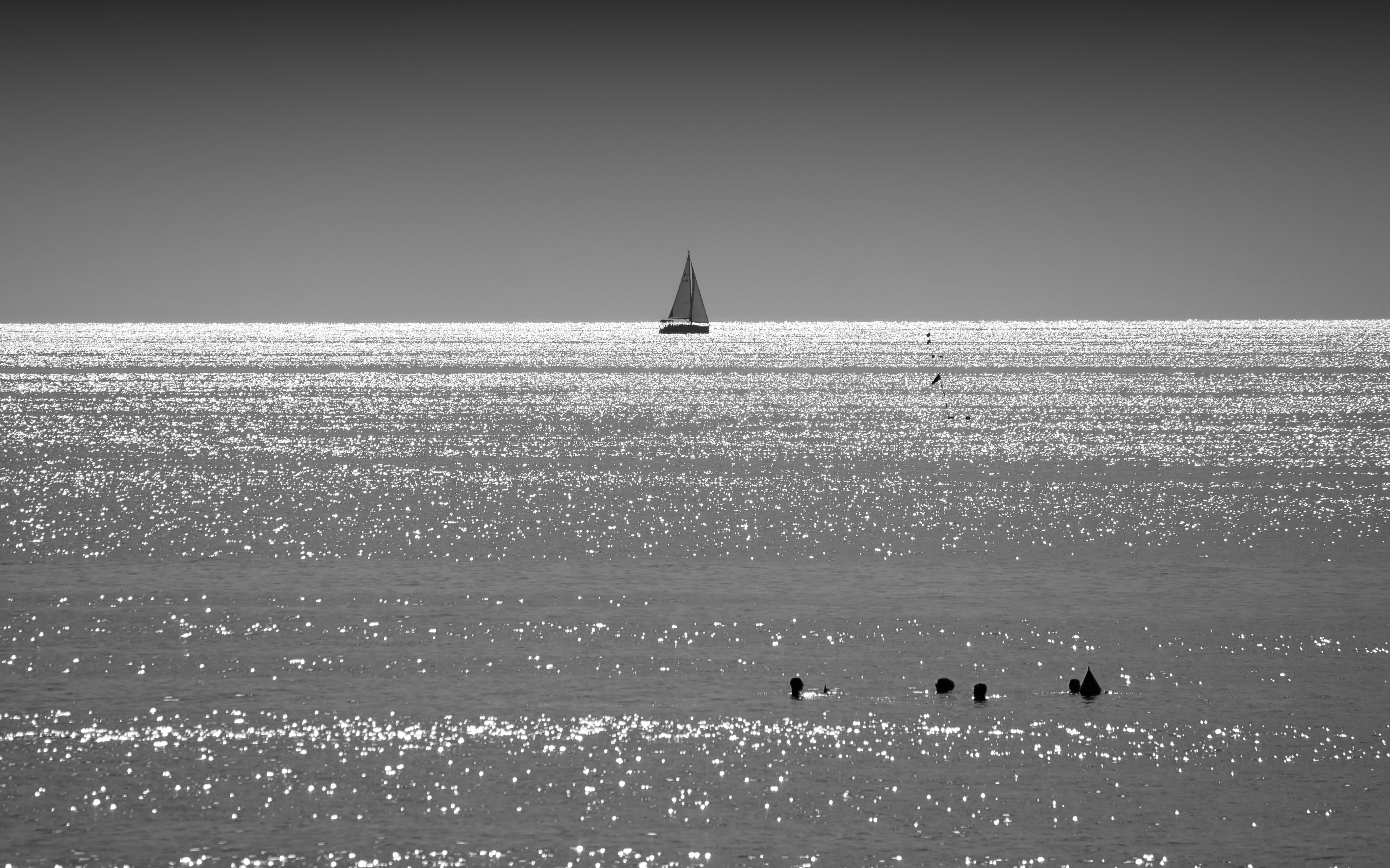 Sailor’s Silhouette on a Glimmering Sea