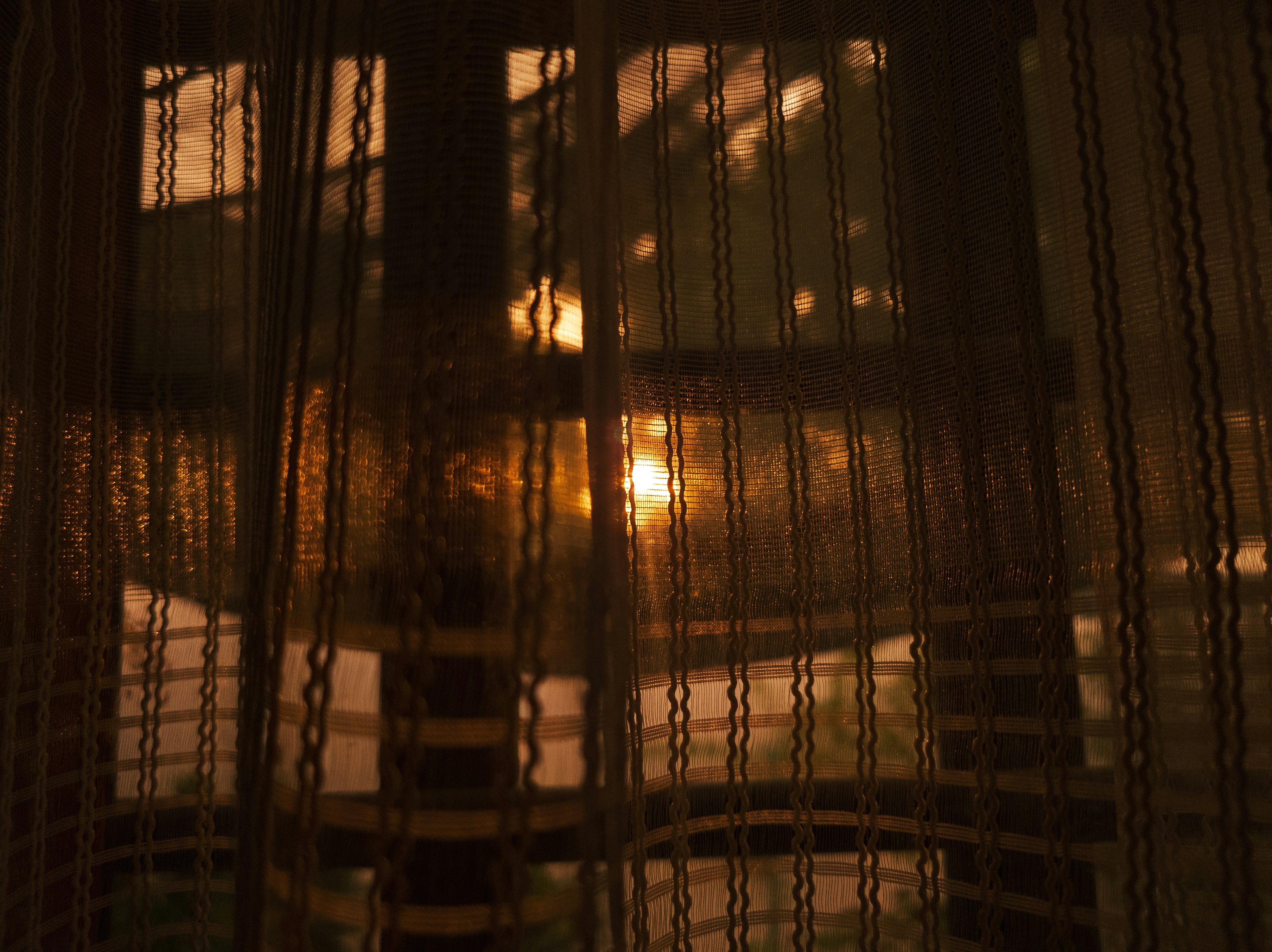 Sunlit Gaps: Window Drapes and Strands Between the Light