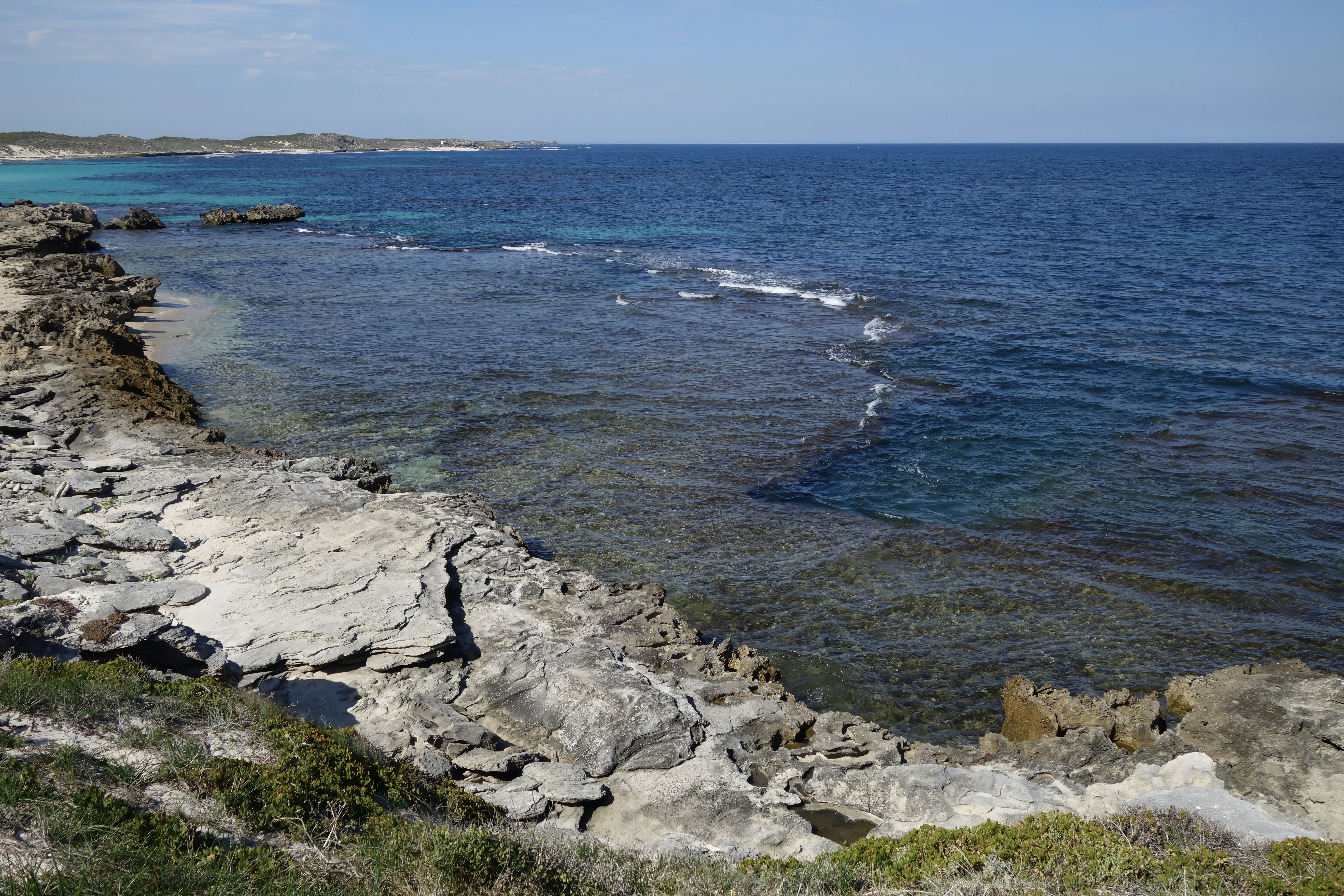 Rugged shoreline in a quiet blue expanse
