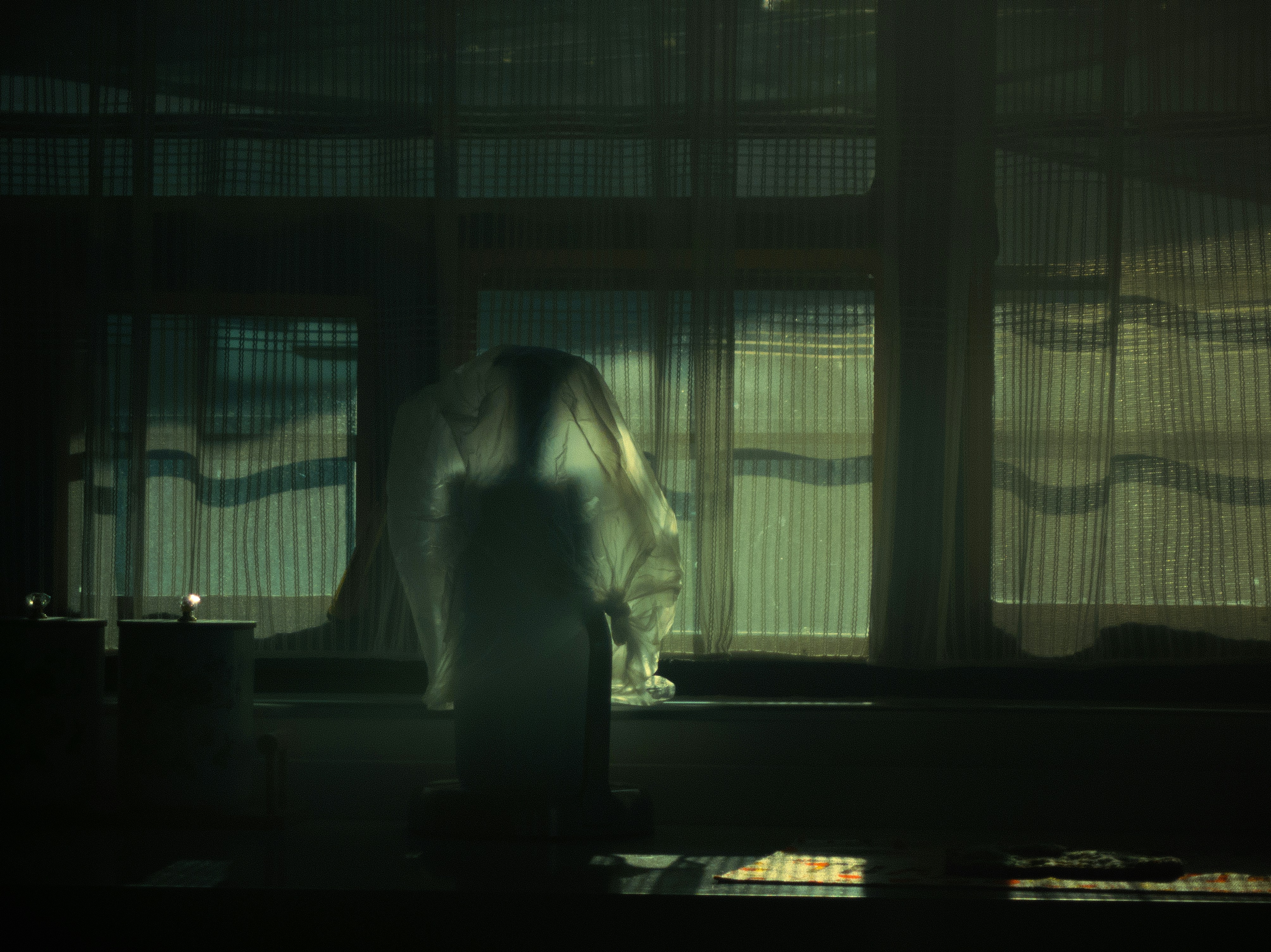 Ghostly Figure in a Backlit Curtain Room