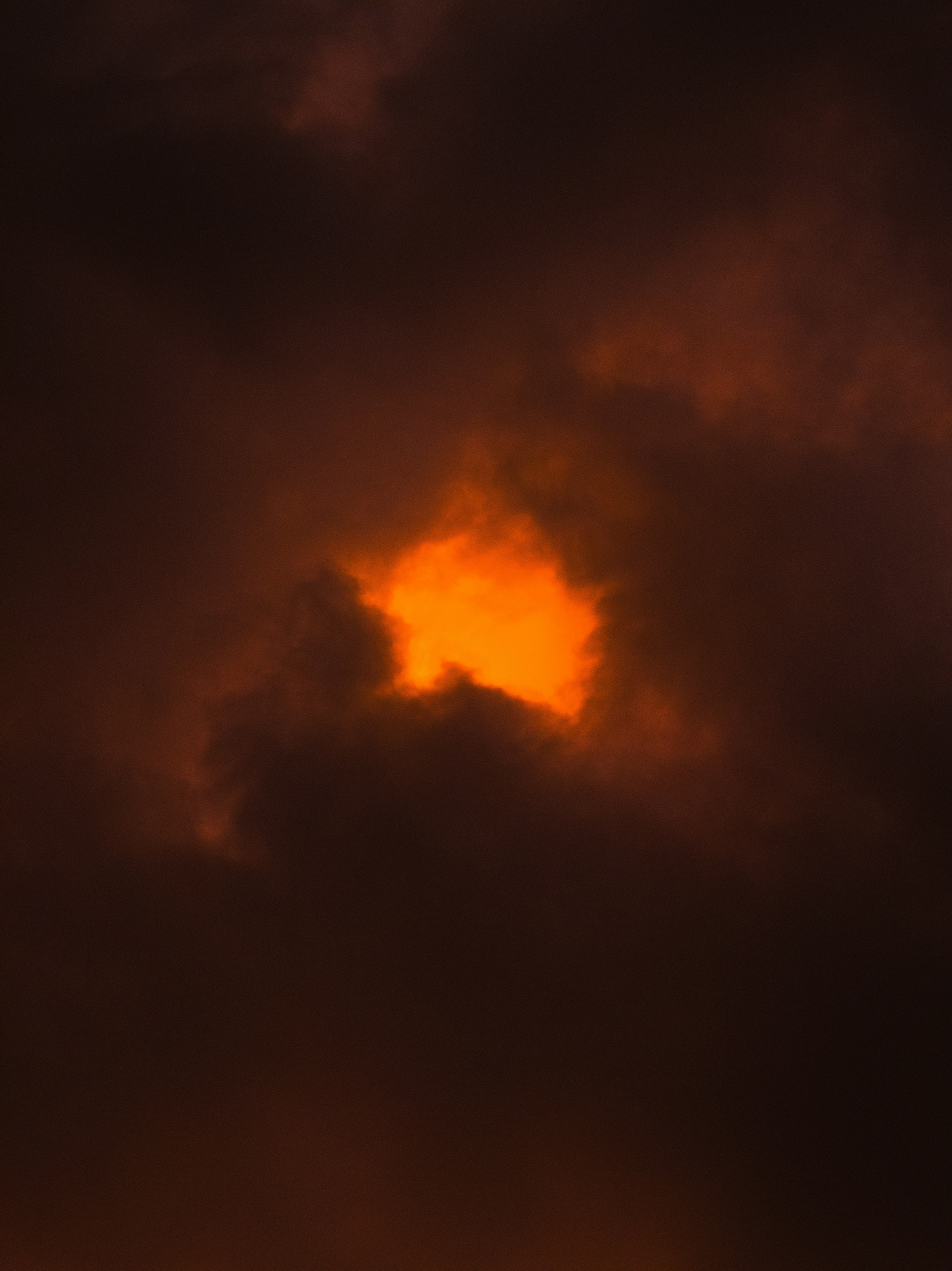Midnight Ember: A Single Glowing Crest in Dark Clouds