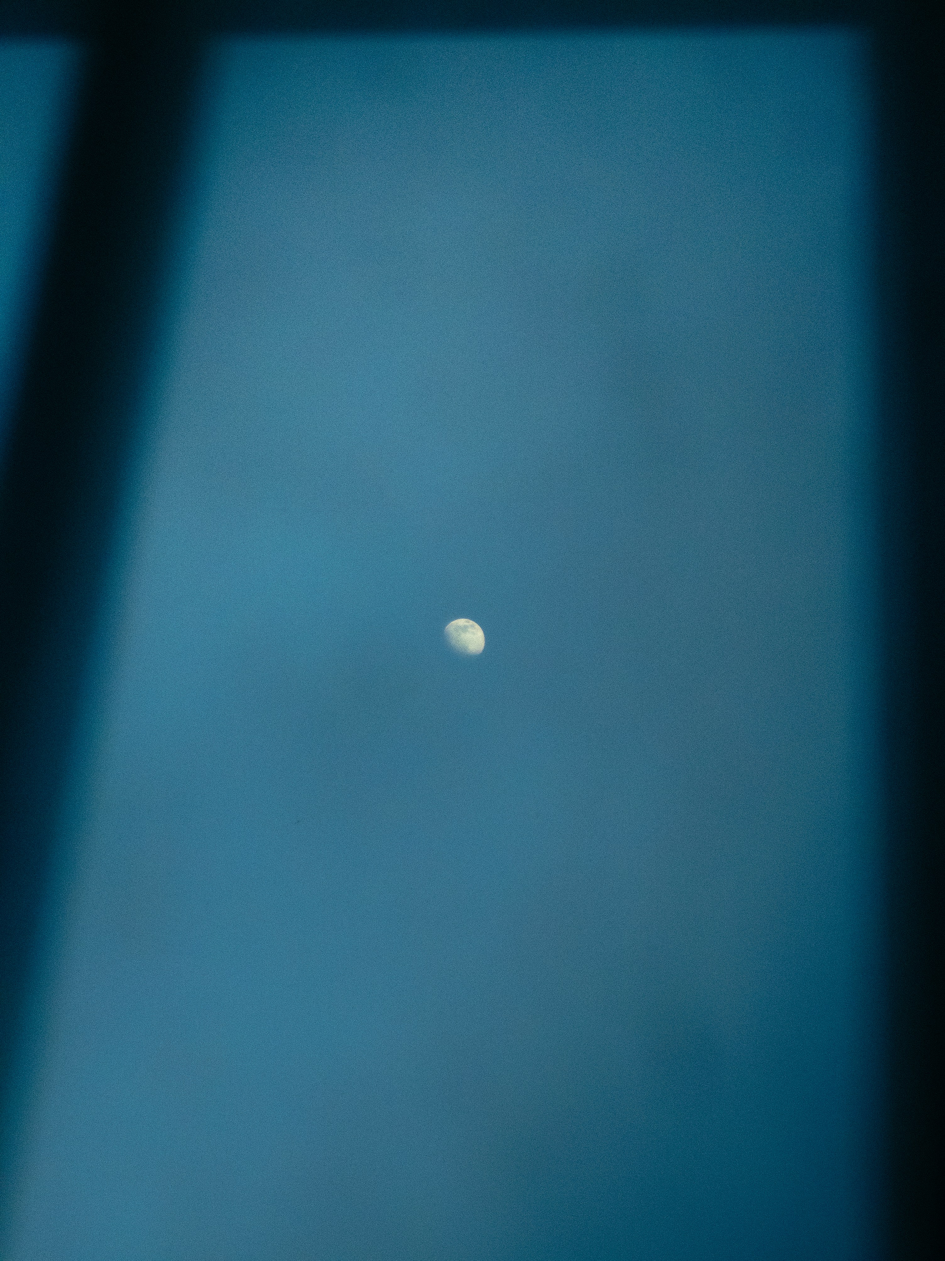 Moon in a Narrow Frame: Blue Window with Soft Vignette