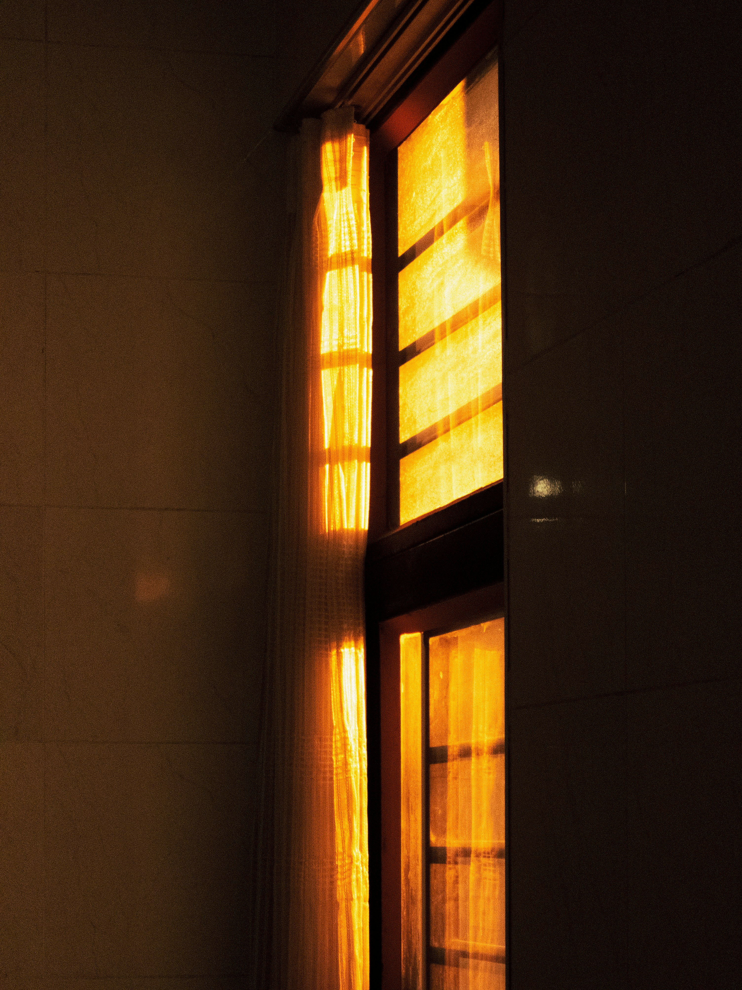 Golden Window: Veiled Light Through Dim Interior