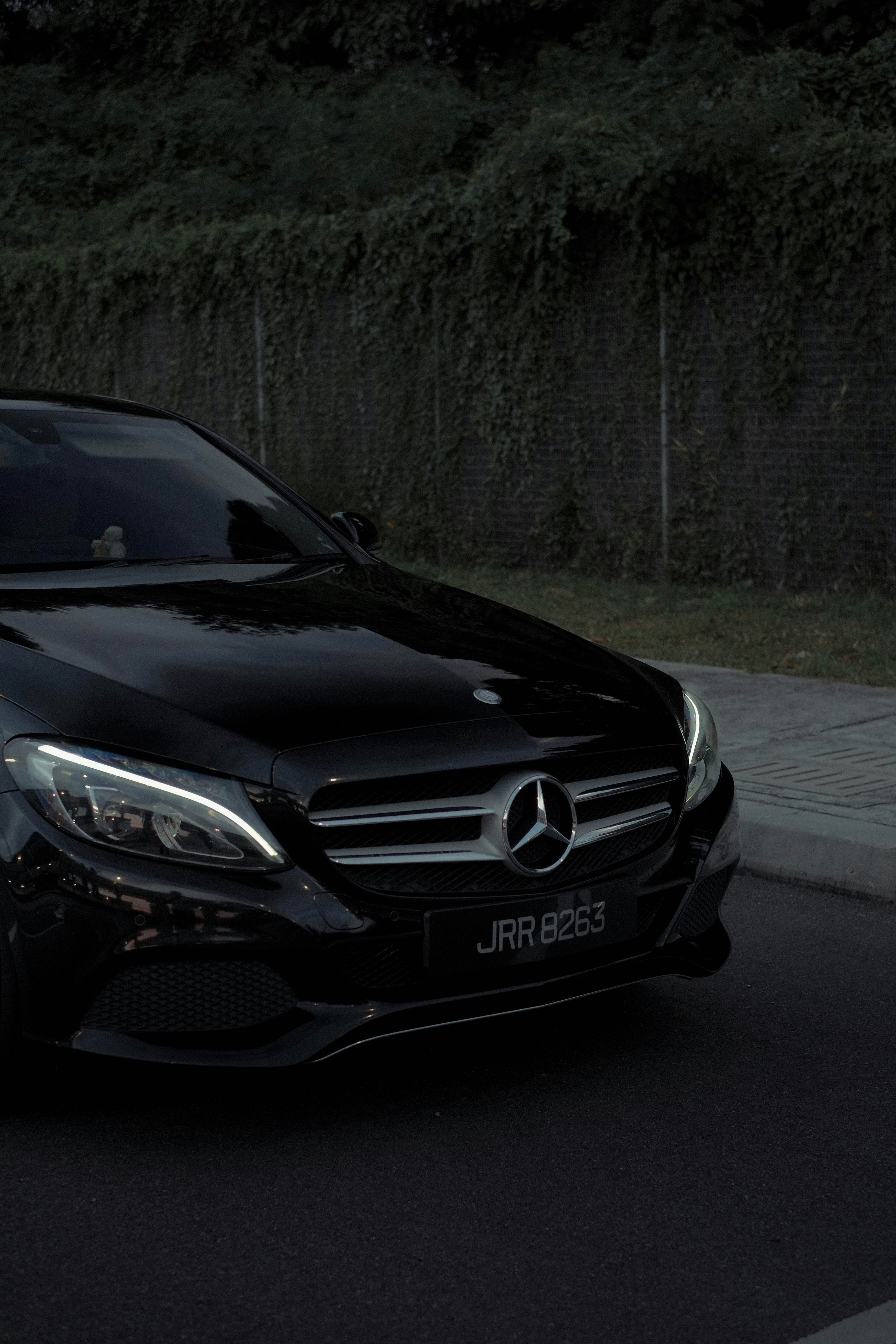 Dark chrome in motion: a Mercedes prow in the evening hush