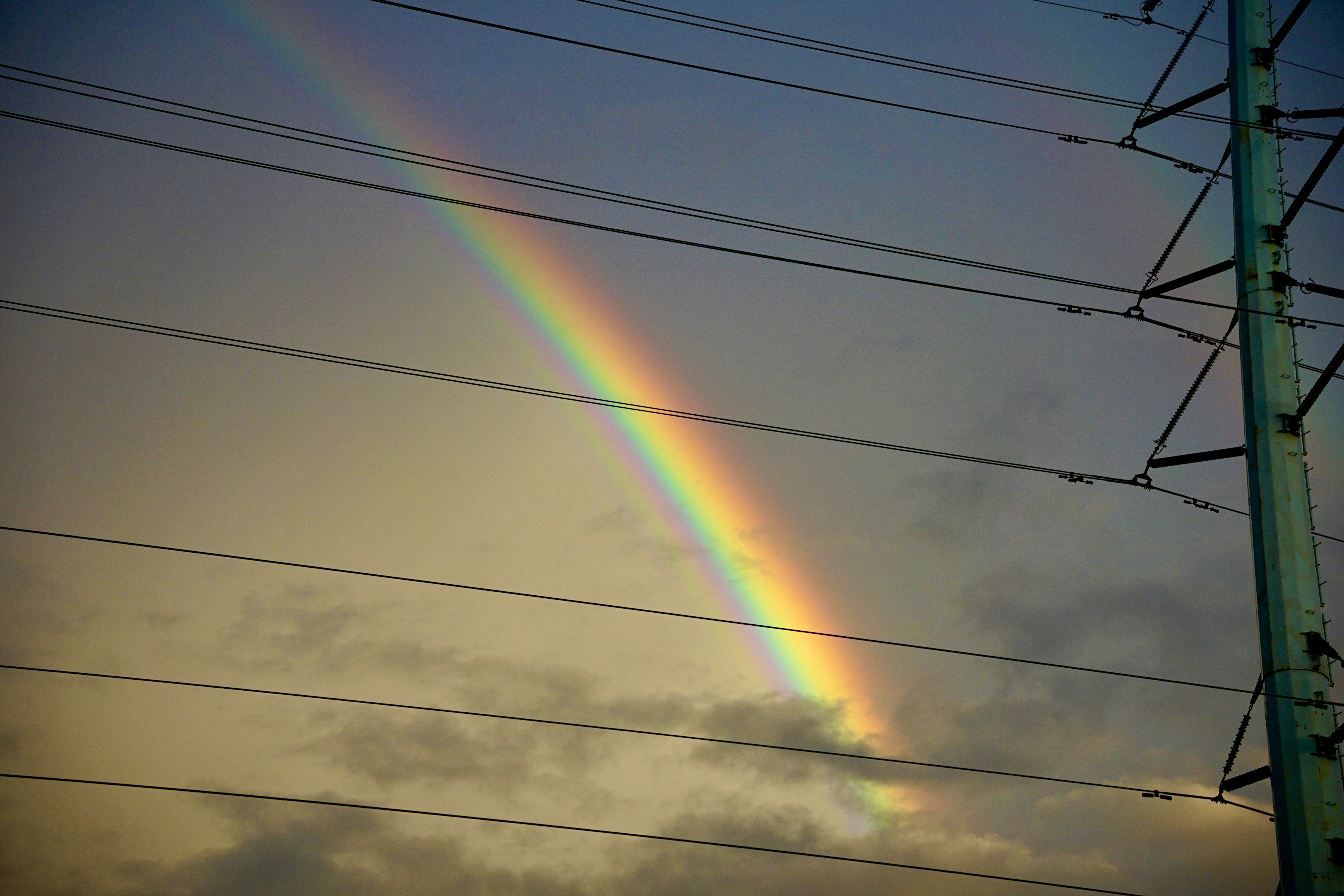 Rainbow Arc Crossing An Industrial Sky