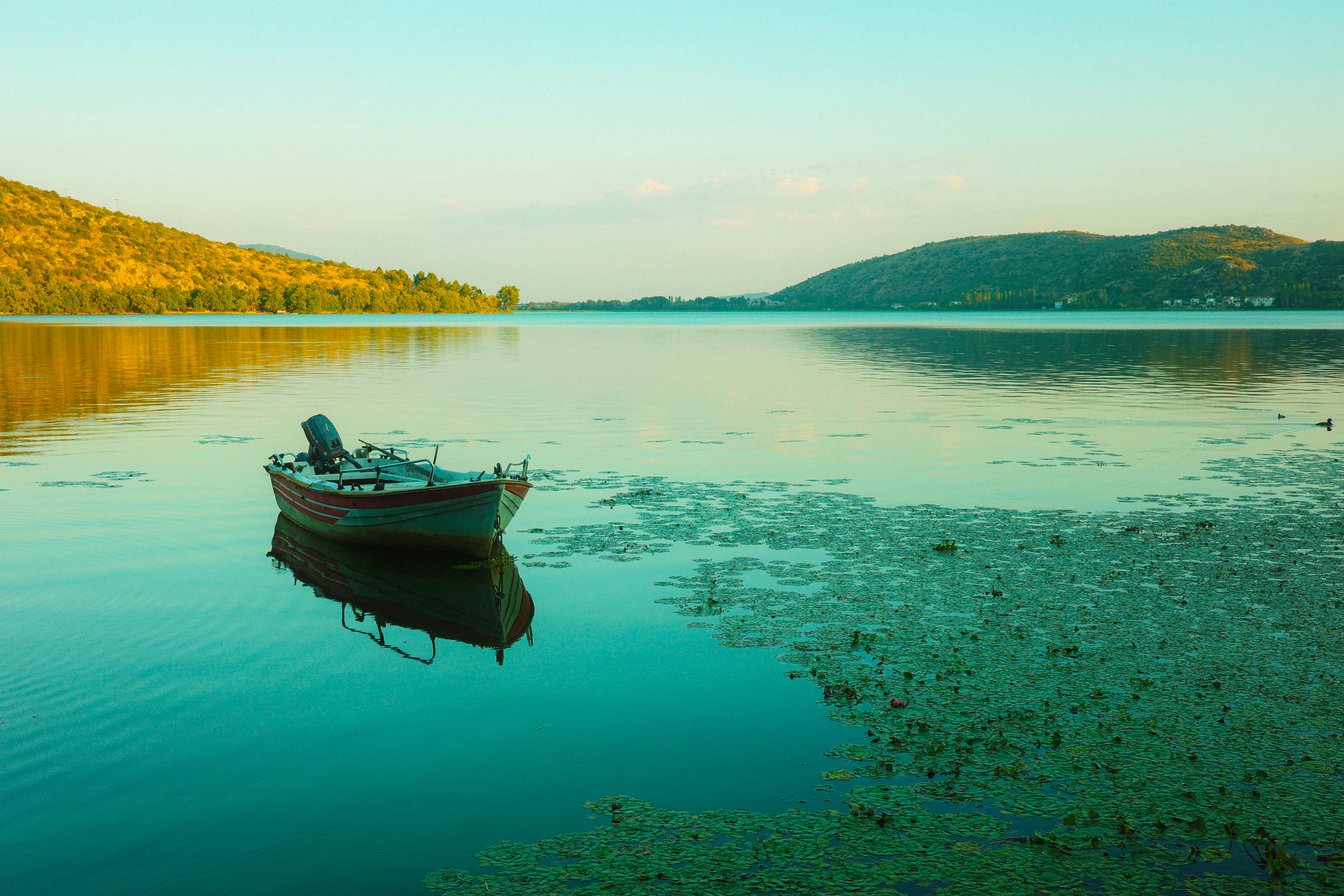 Solitary Boat on a Glassy Gulf at Dusk