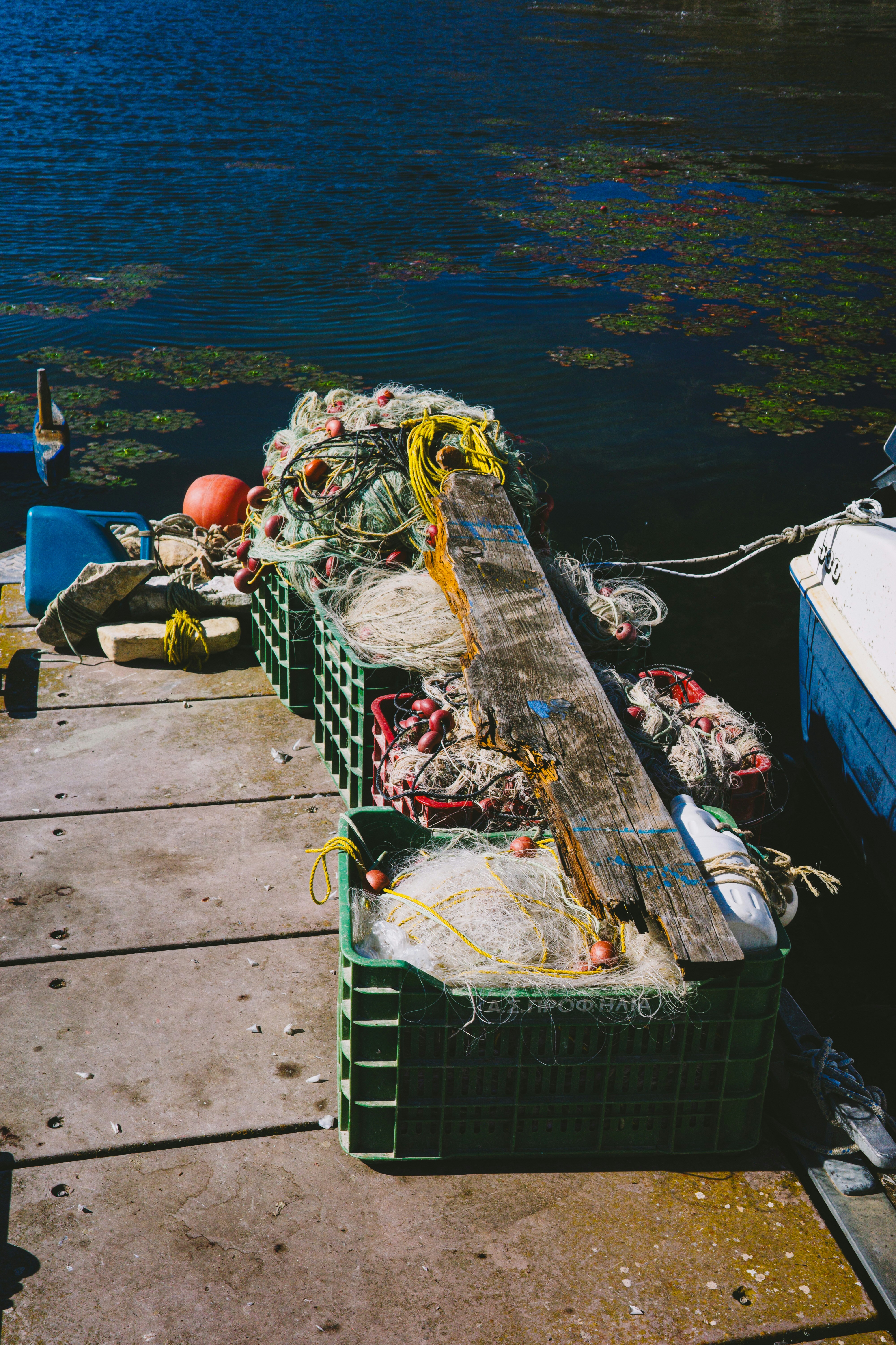 Harbor Tackle: A Crate of Nets and Foam Floats by the Pier