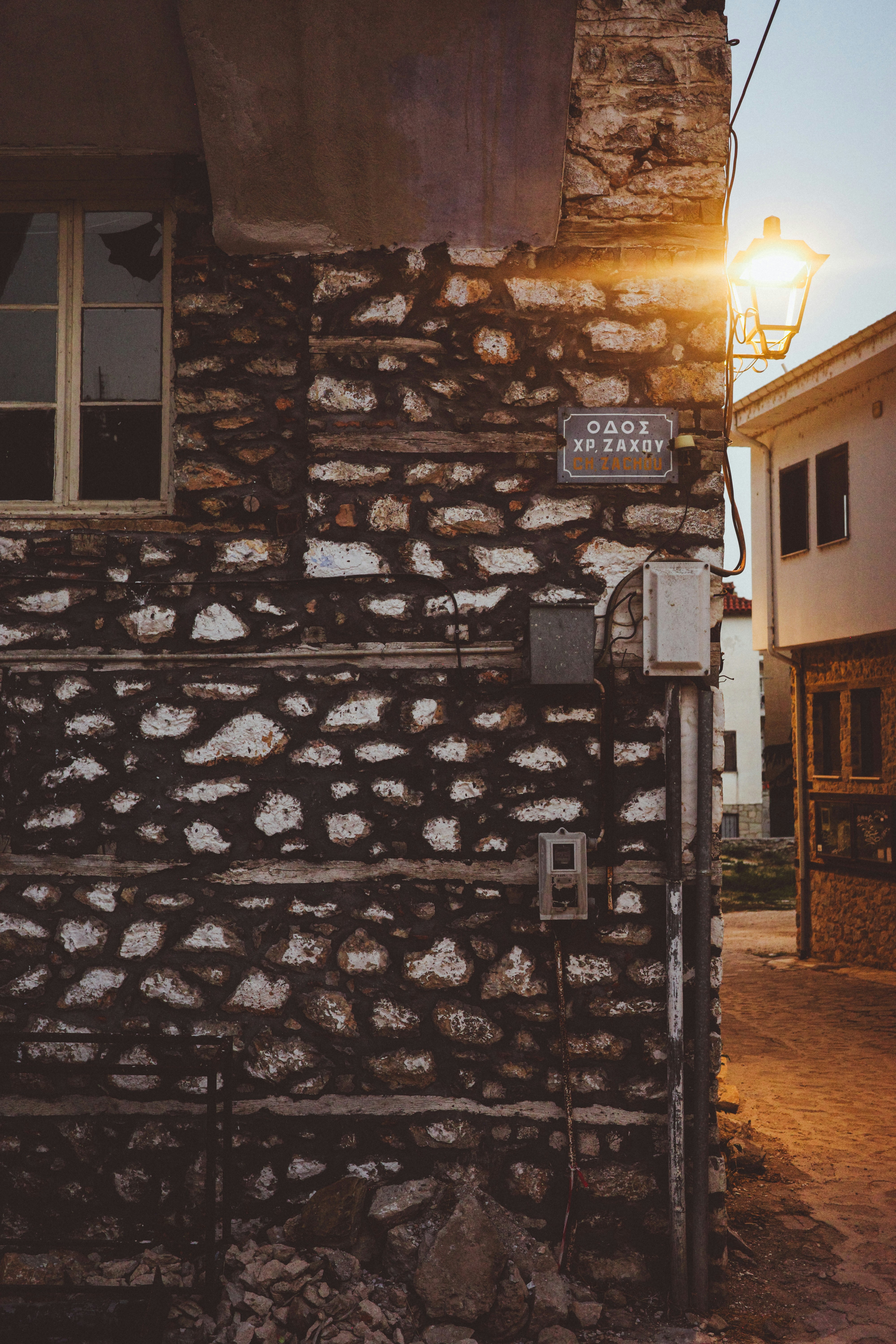 Sunlit Corner: A Rustic Stone Facade at Sunset