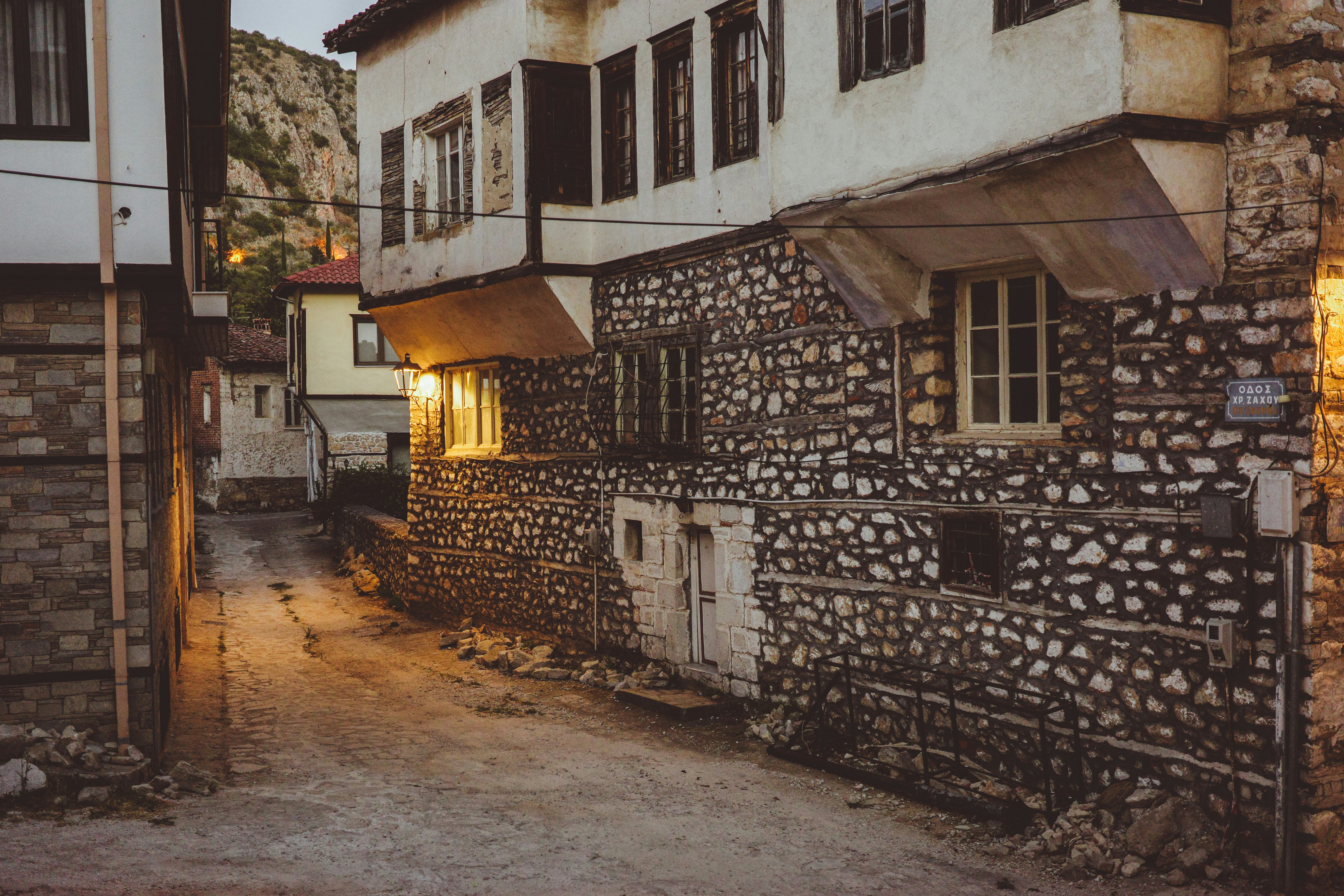 Lantern-lit Stone Lane Between Timeworn Homes