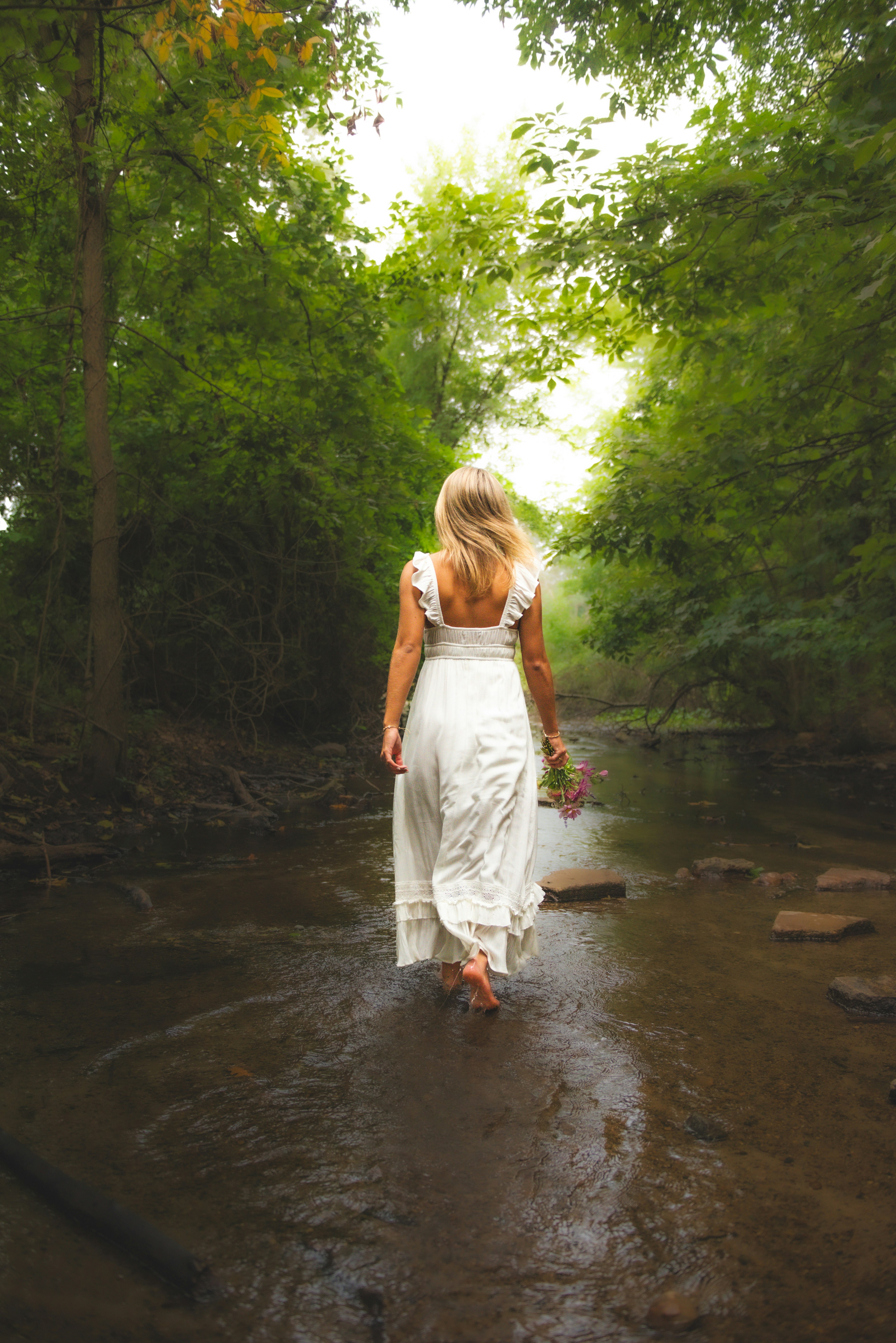 White Dress in a Quiet Creek: A solitary walk toward the light