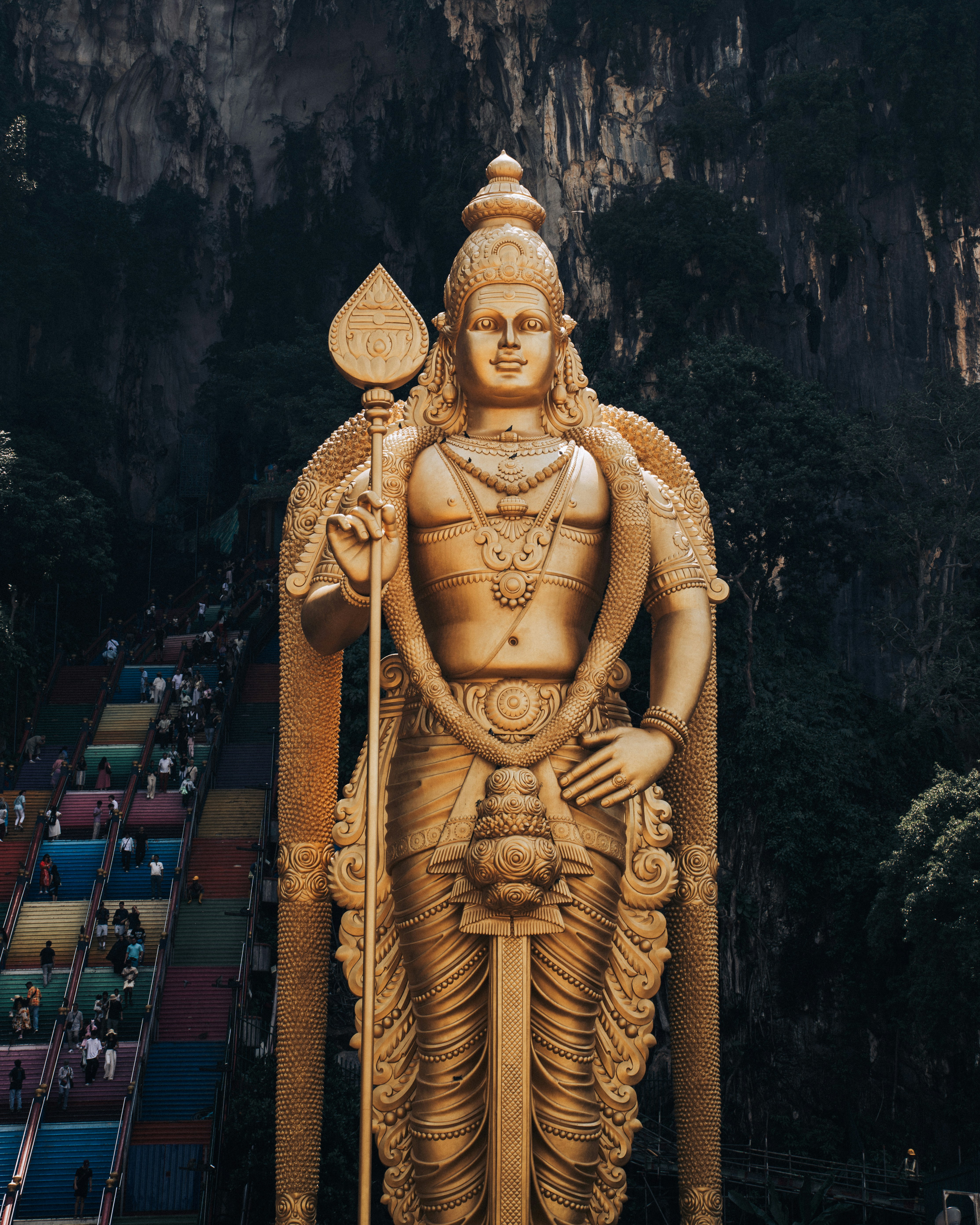 Golden Guardian: A Sacred Colossus Framed by Quarry Cliff