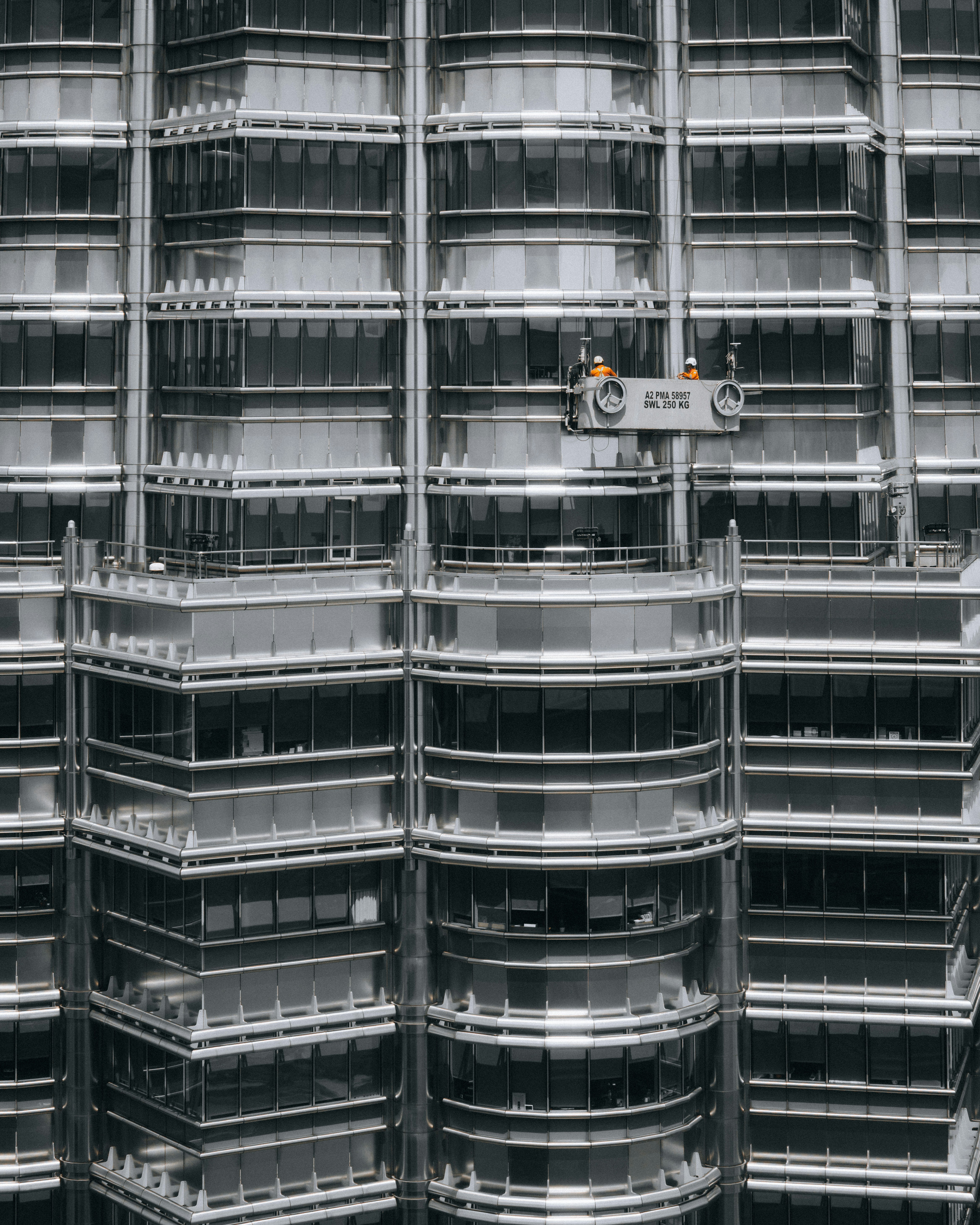 Facade Overlook: Workers at the Edge of a Glass-Chelated Sky