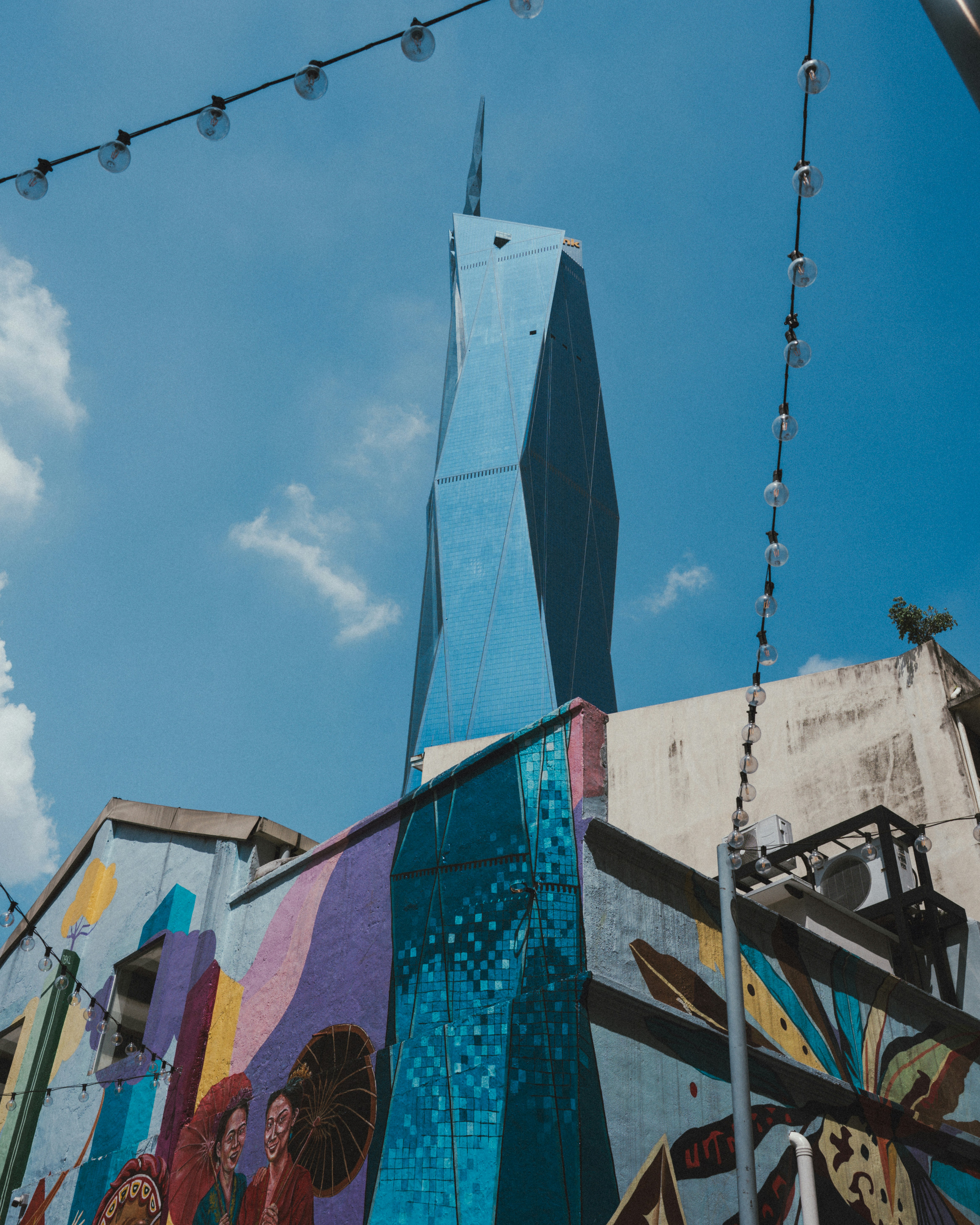 Azure Tower Reaching Above Street-Art Facade