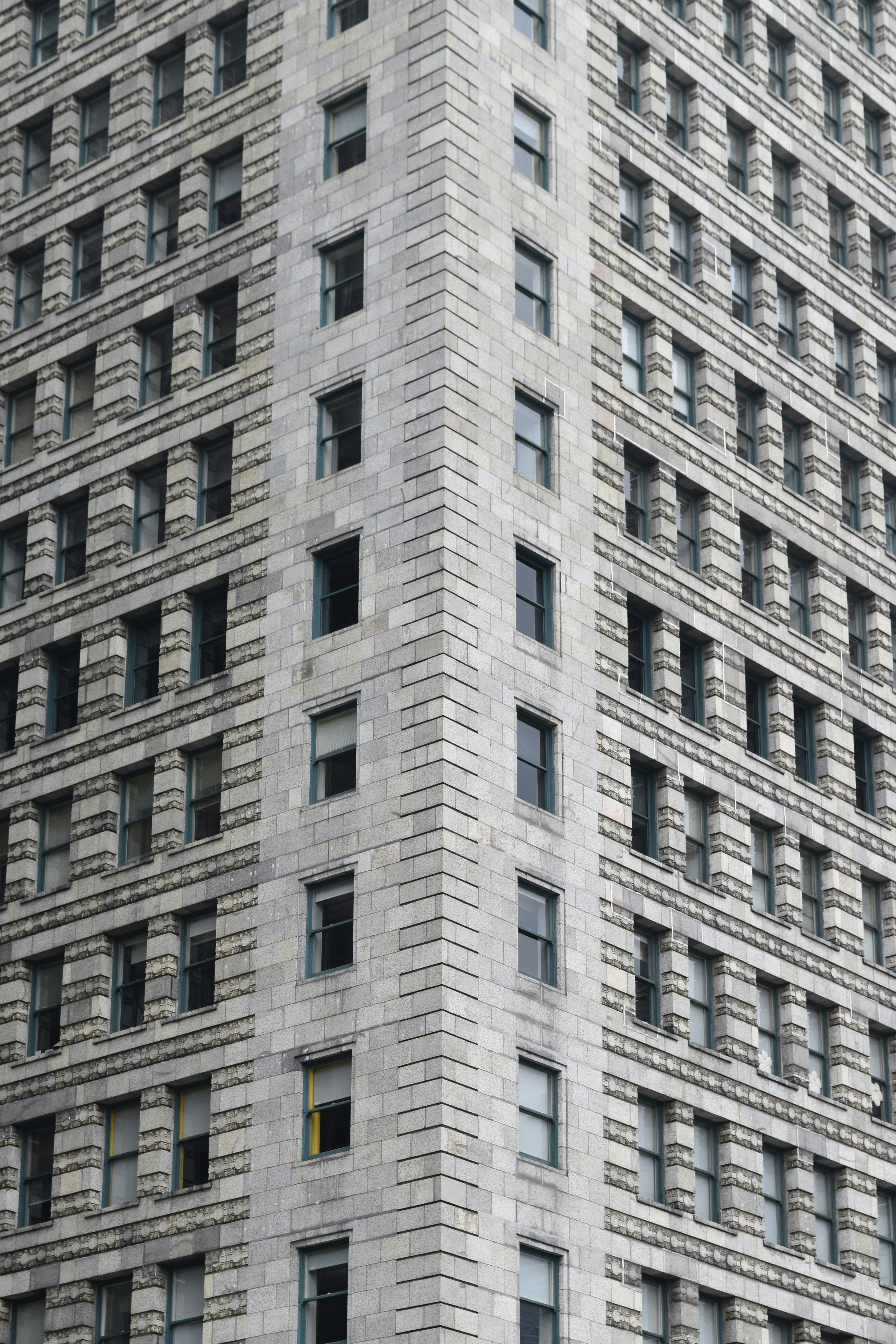 Cornerstone of Stone: A Skewed Facade Repeating into the Sky