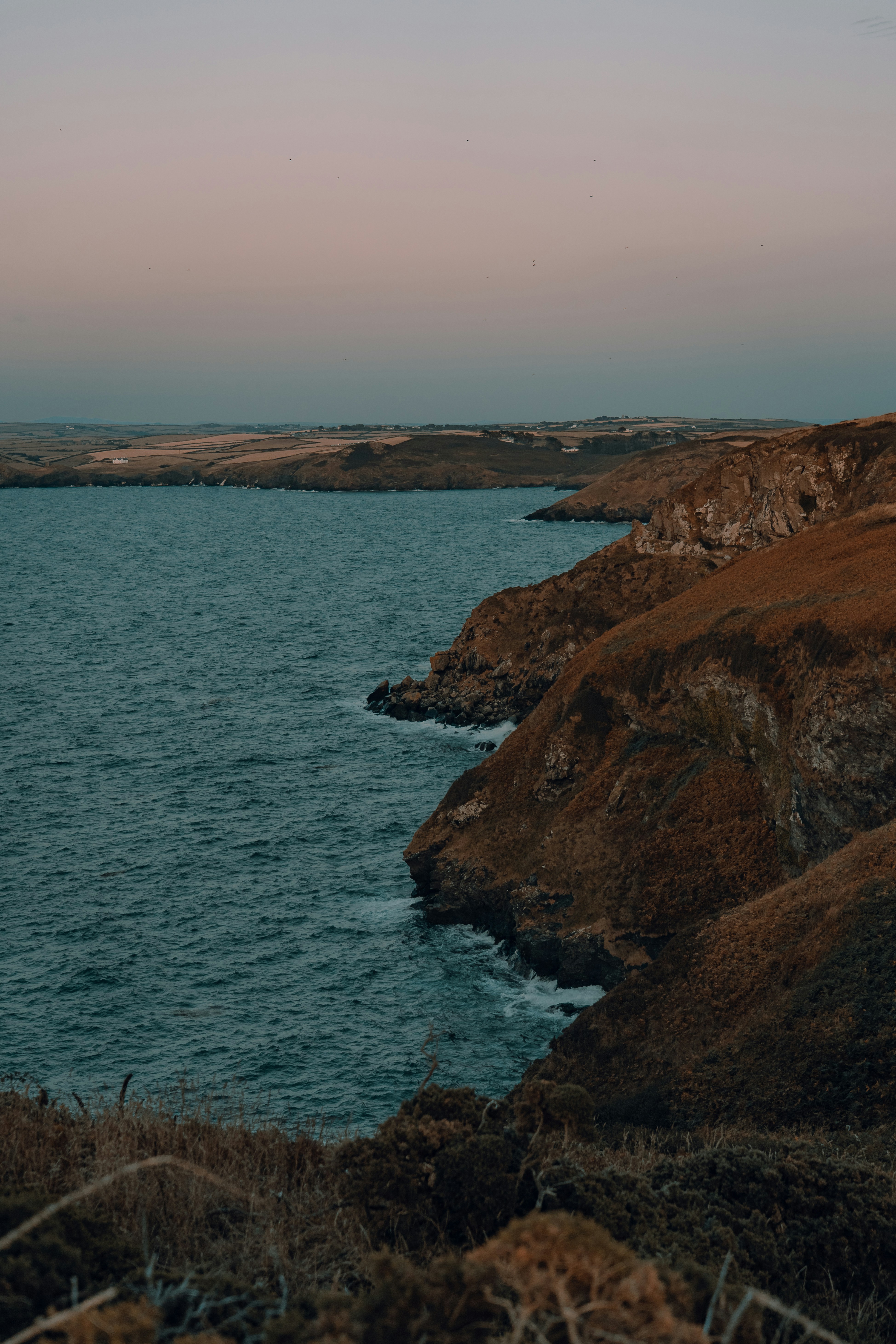 Horizon of Rock and Sea at Dusk