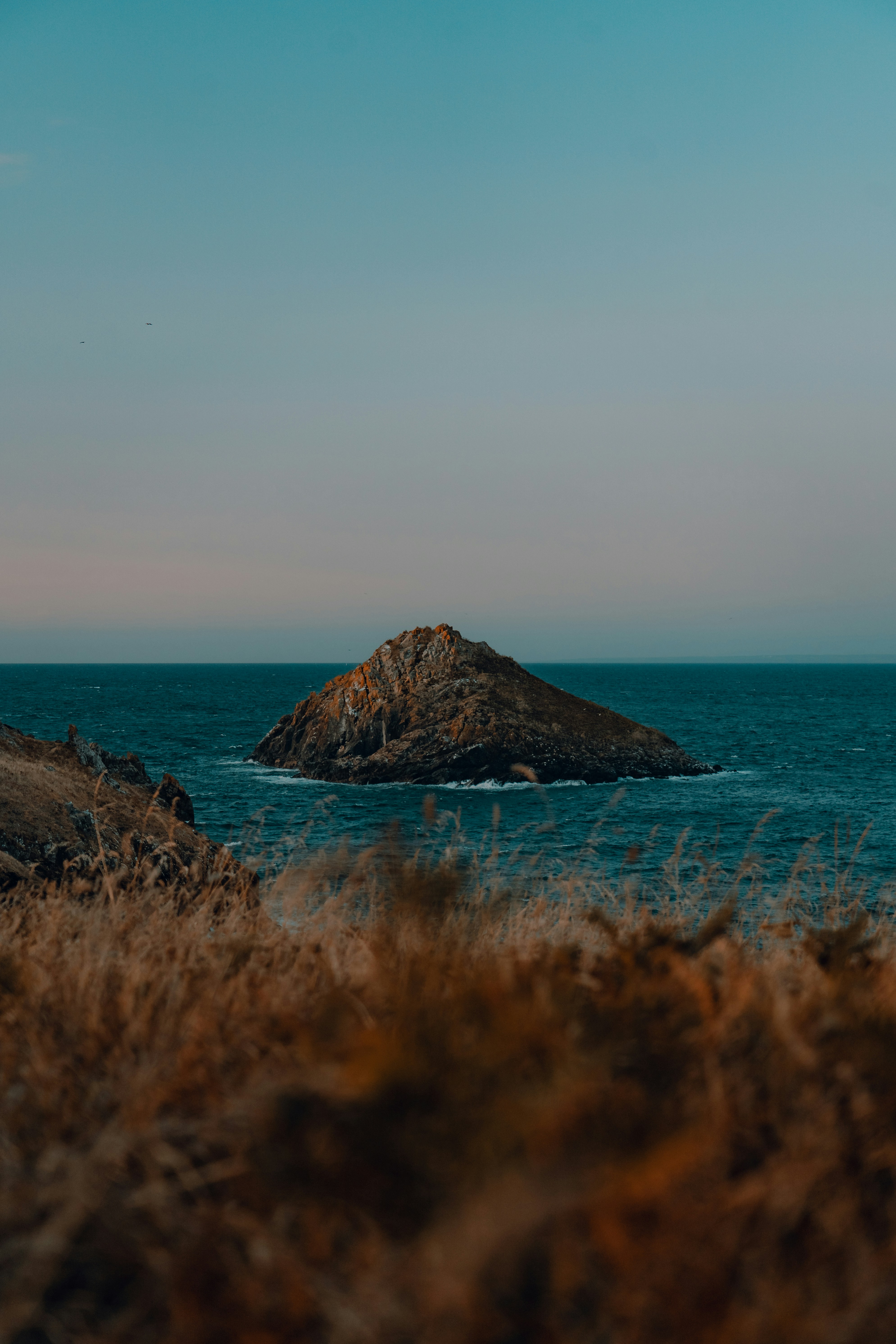 Rock Island Quiet: A Lone Promontory Stands Between Sea and Sky
