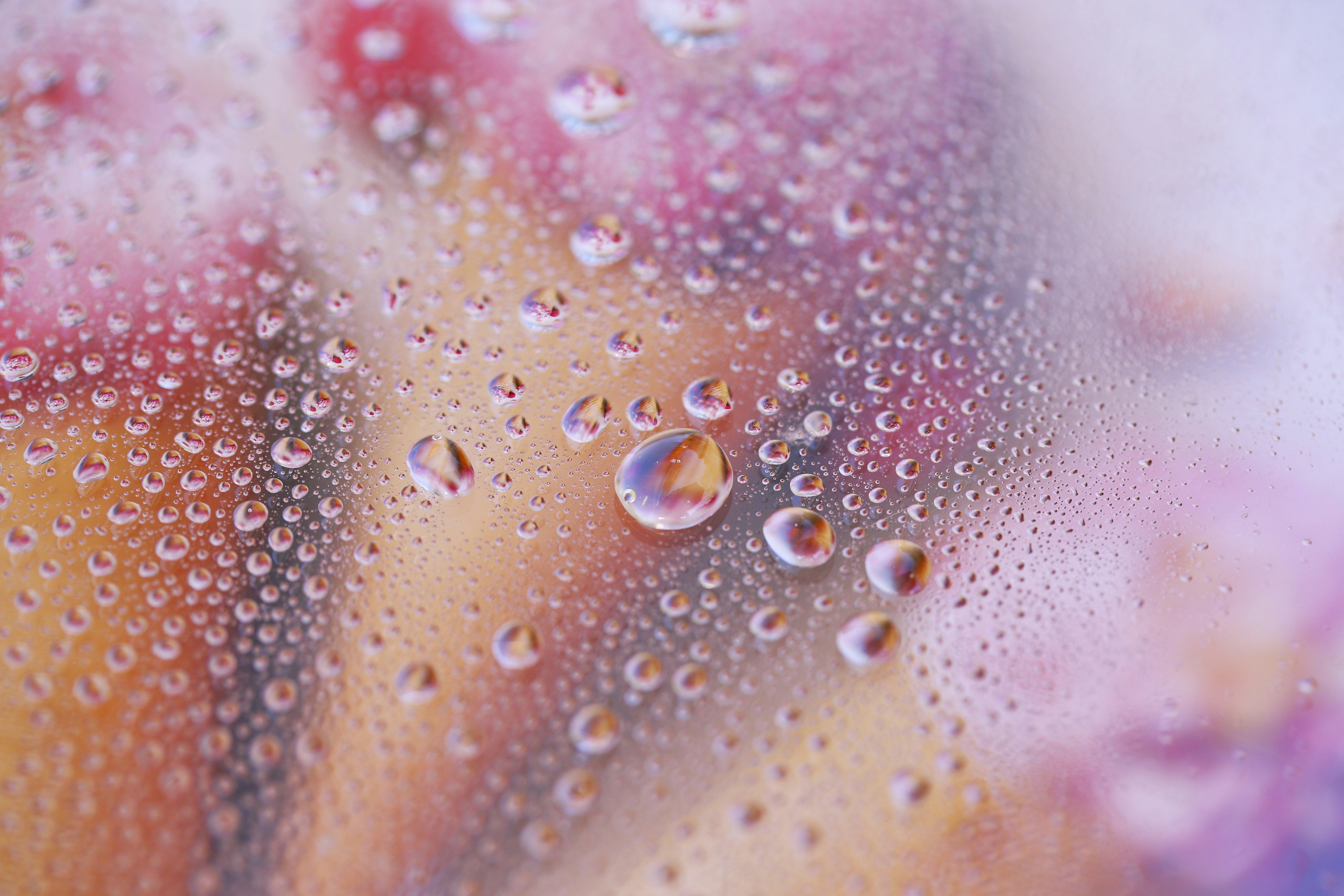 Bokeh Beads: Macro Rain on Glass revealing colorful blur