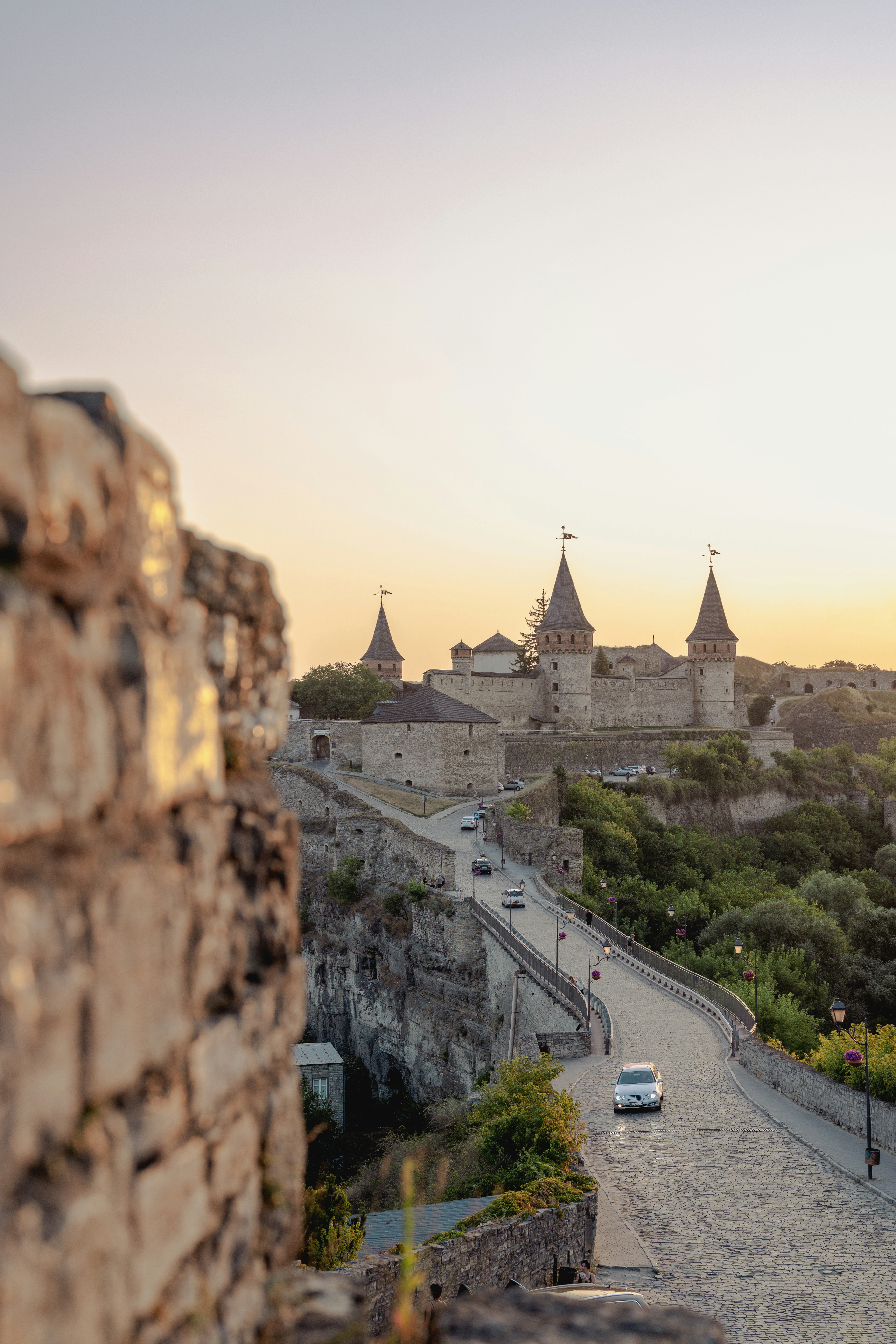 Sunset Over the Fortress: A Cobbled Path to the Towers