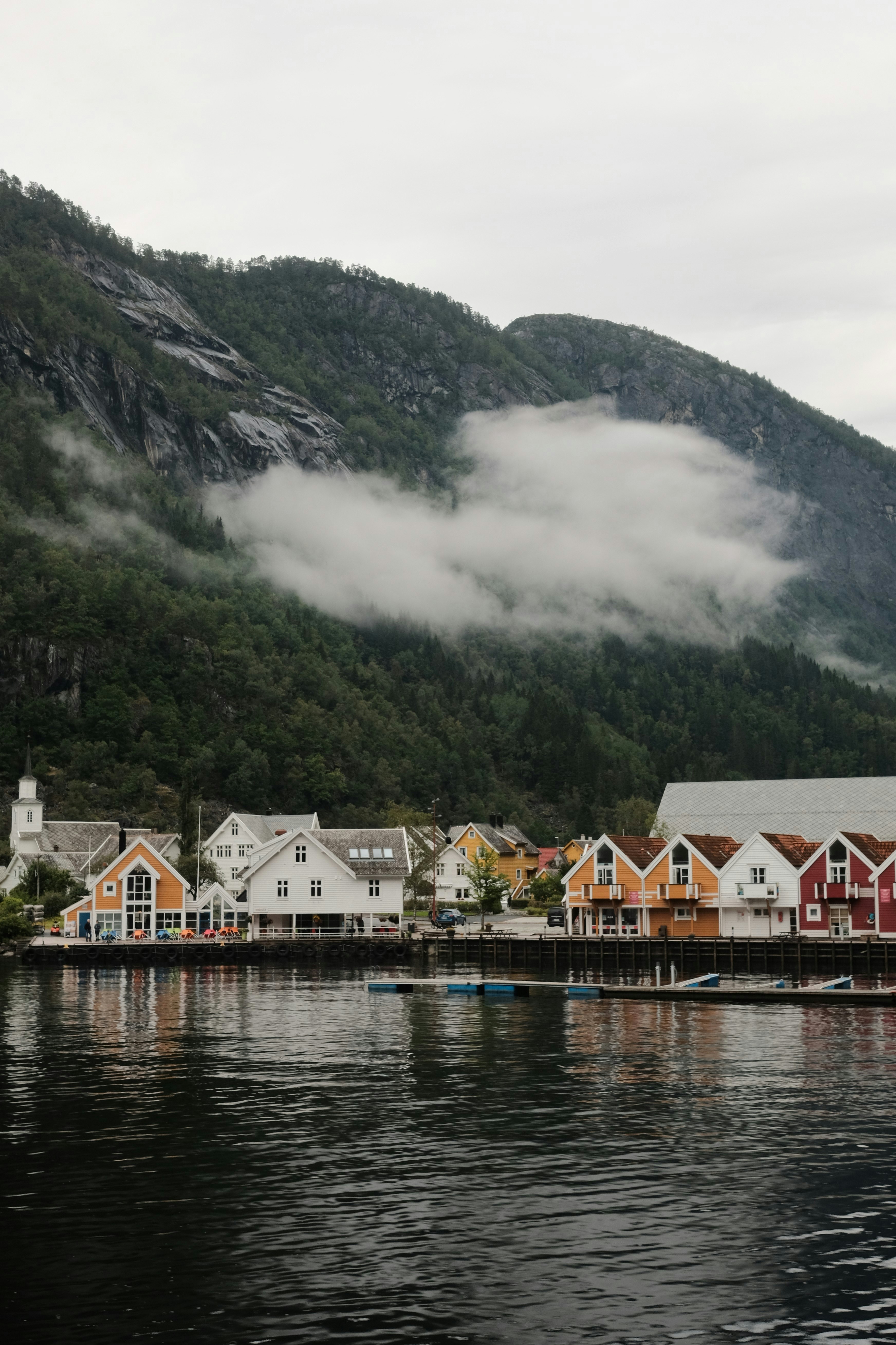 Colorful Fishermen’s Village at the Foot of a Misty Norwegian Inlet