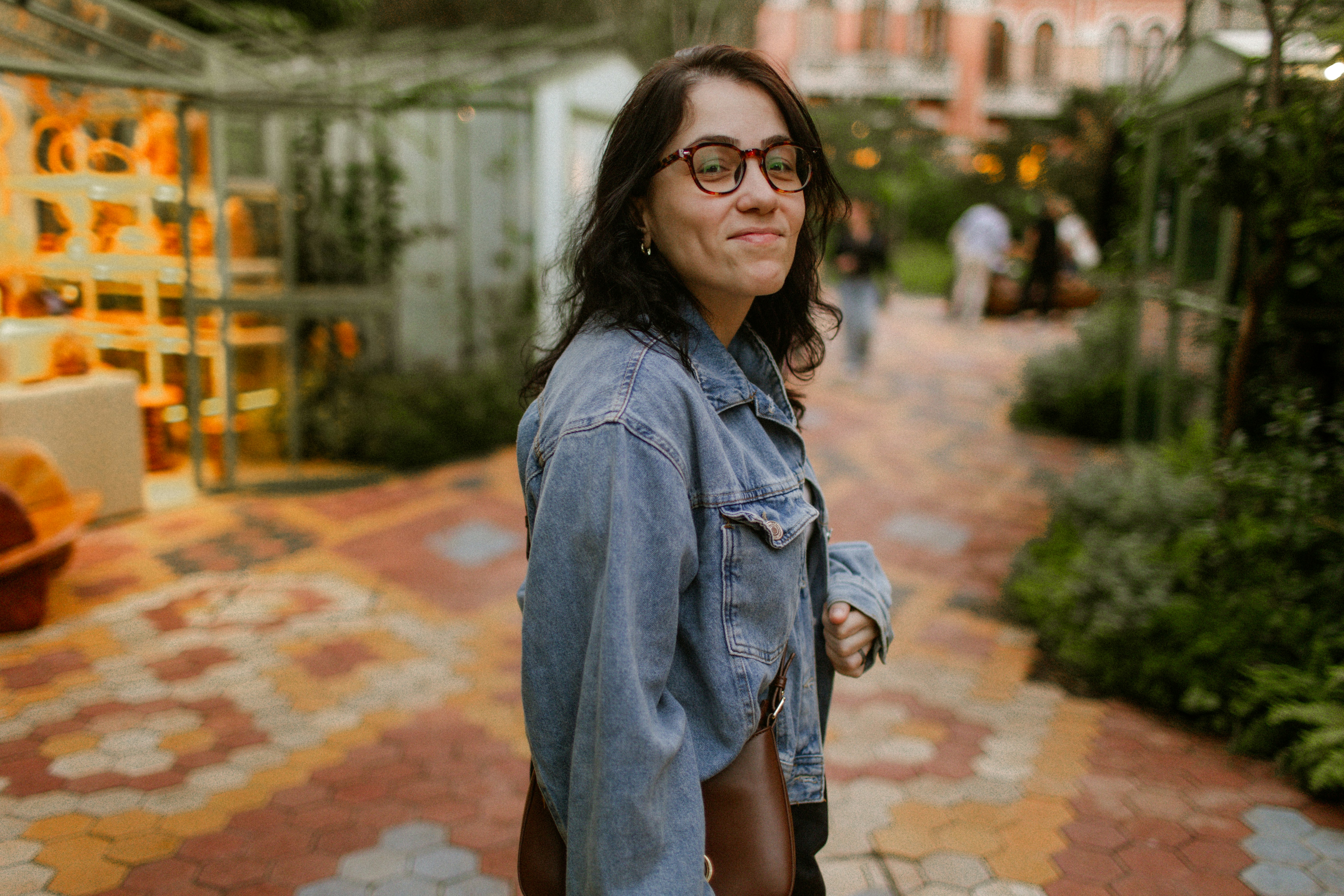 Denim Backdrop: A Casual Moment in a Painted Courtyard