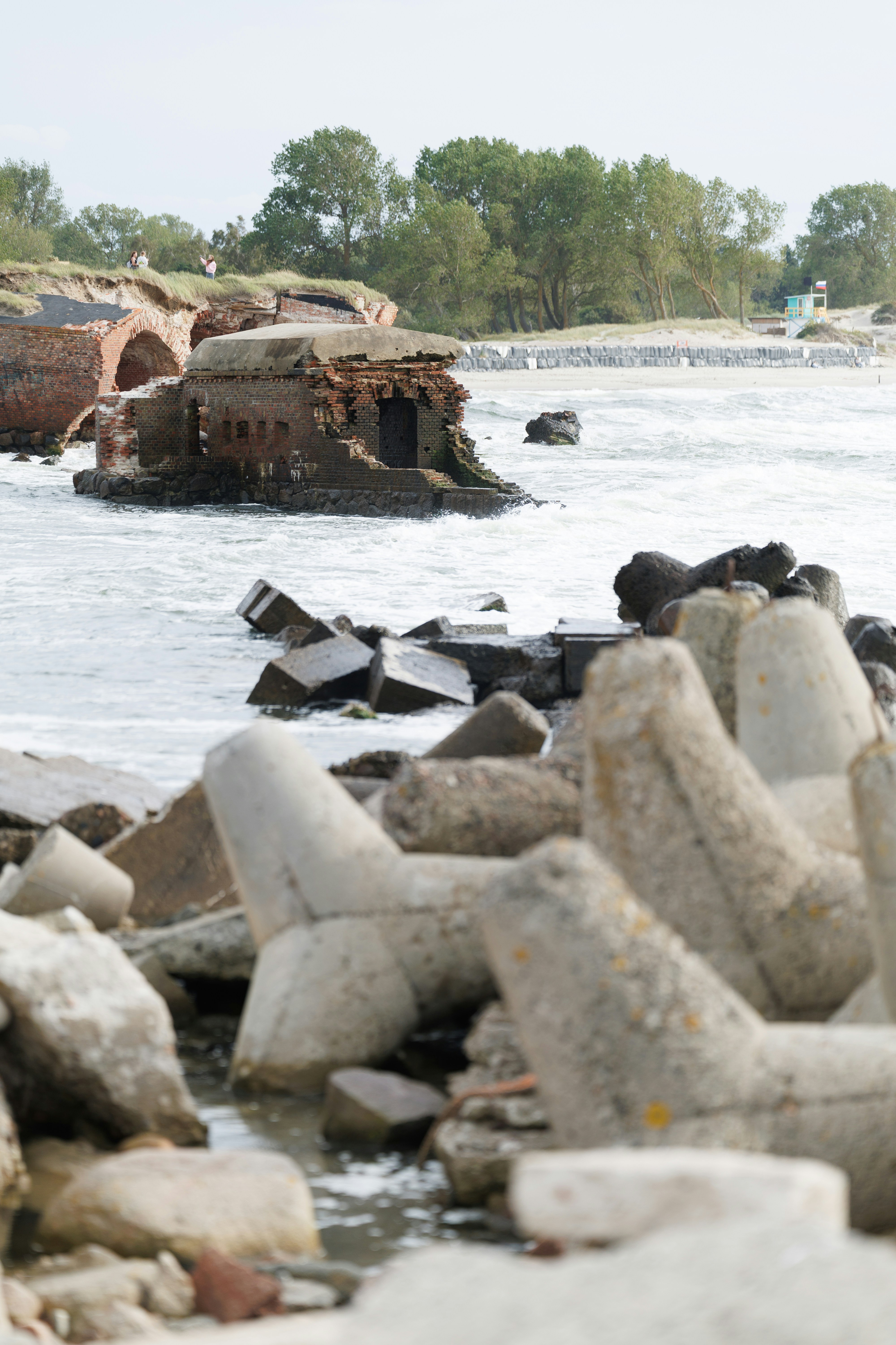 Rusted remains and crashing tides by a broken pier