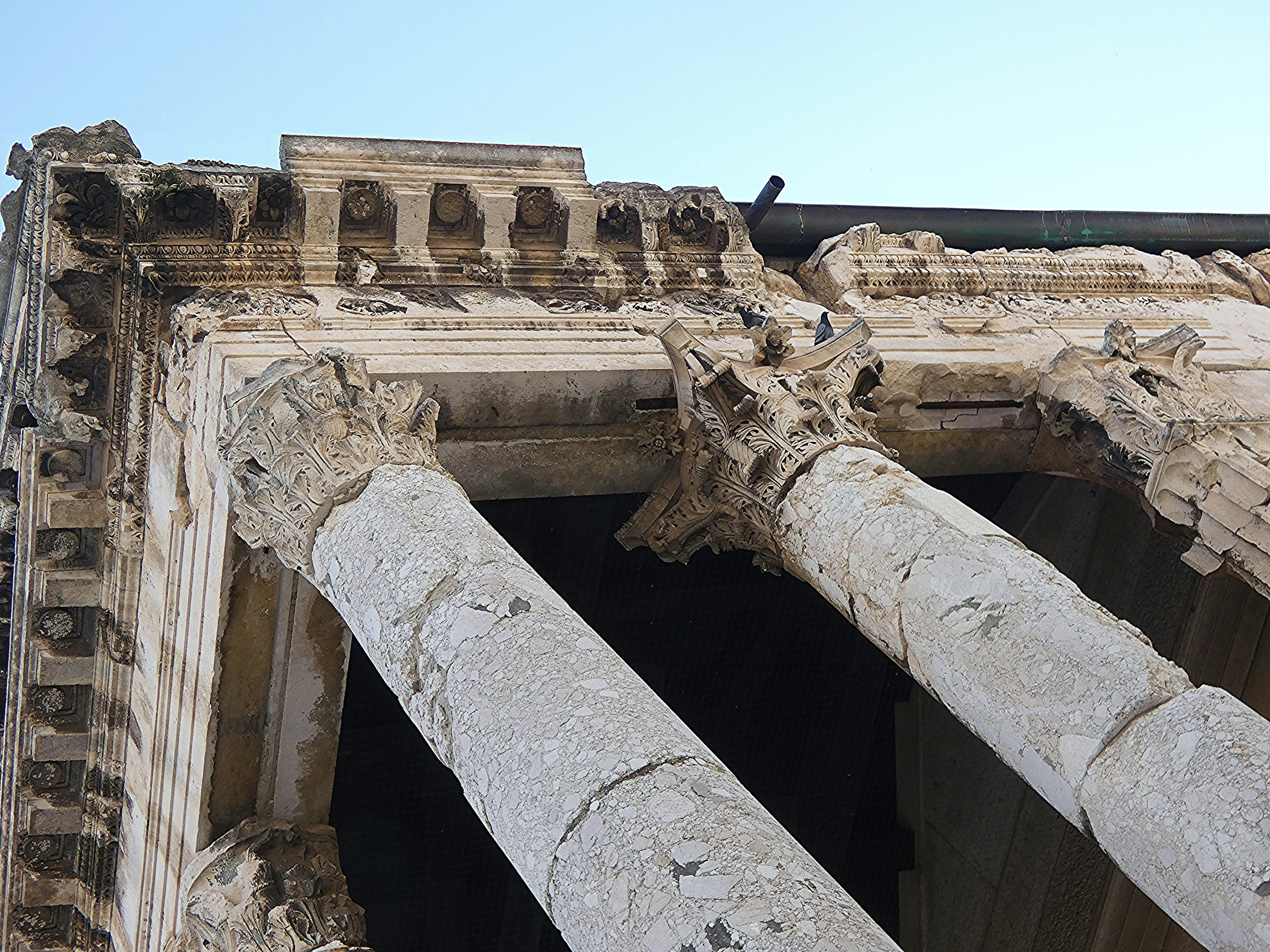Stone Giants: Crumbling Columns Reaching Toward a Clear Sky