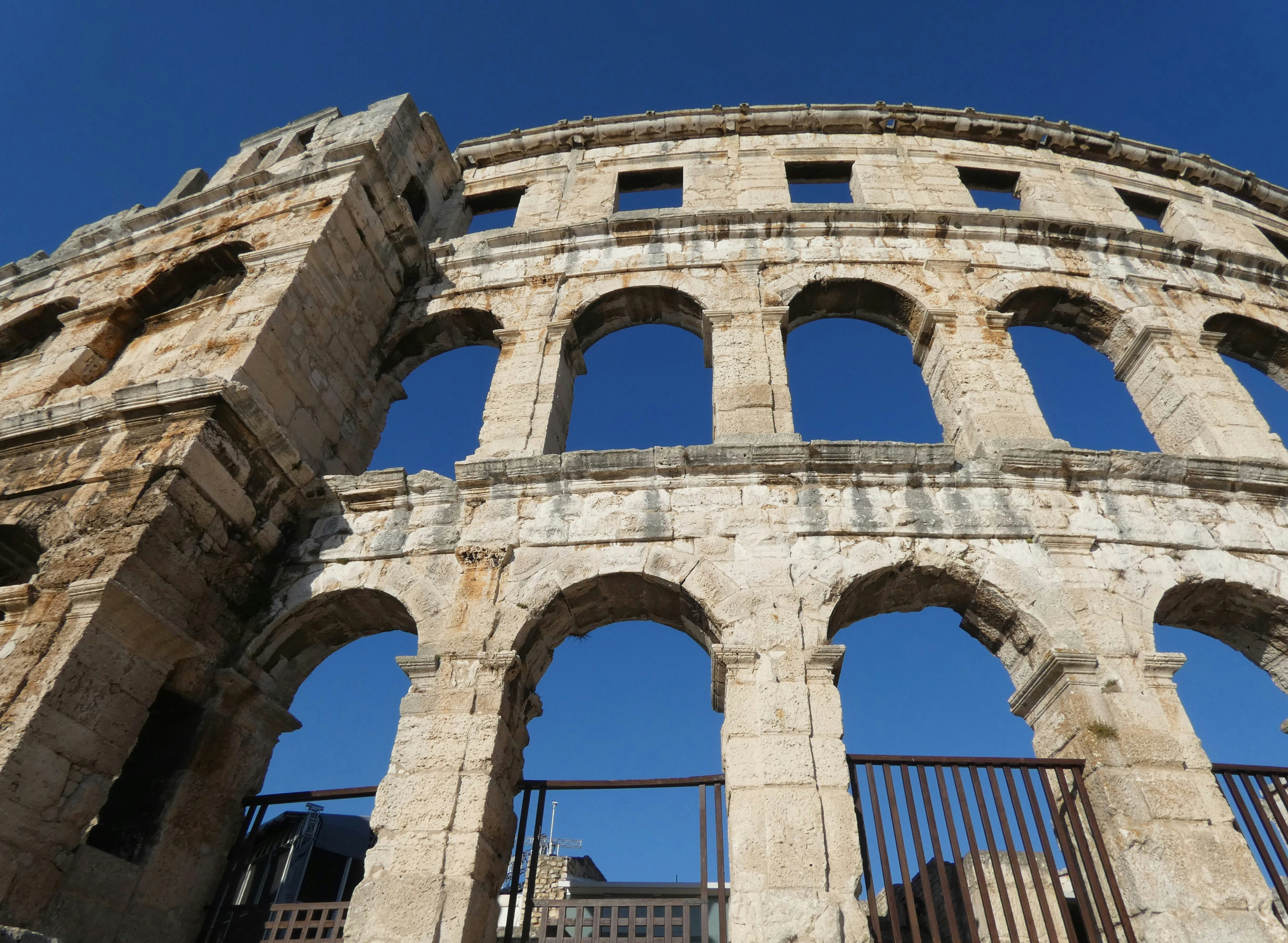Arcade of Stone: The Colosseum Reaches Toward a Clear Blue Sky