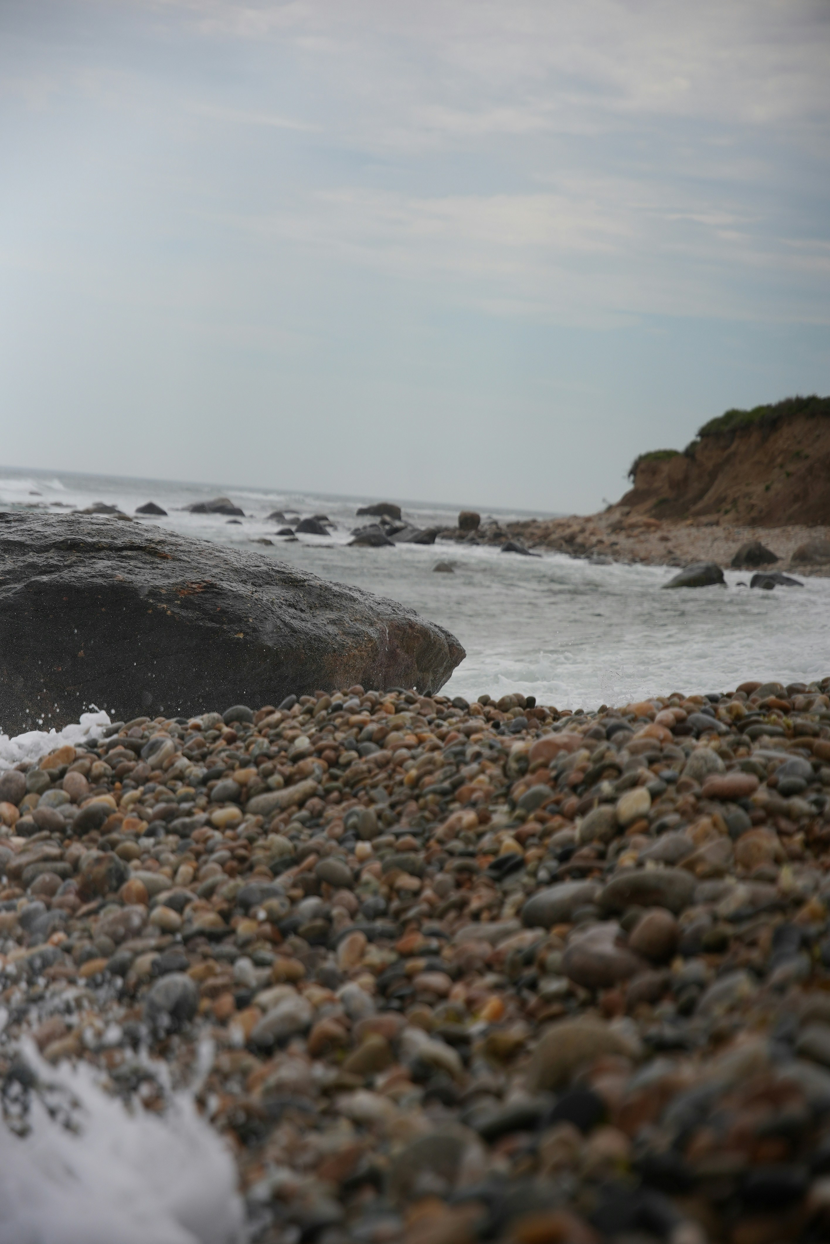 Pebble Beach Along a Quiet Cliffline at Daybreak