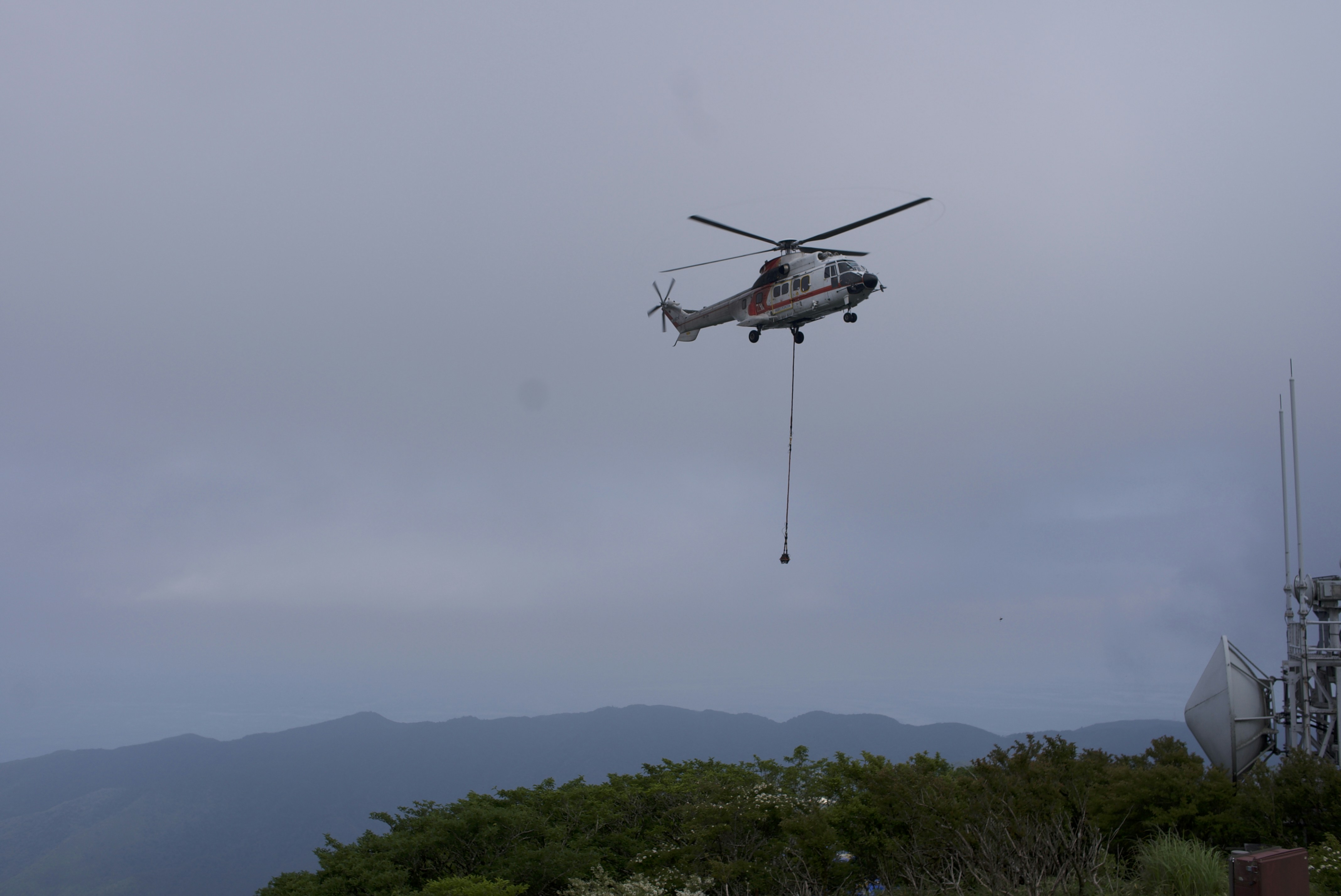 Lifeline Over the Ridge: A Rescue Helicopter Dangles a Nearly Invisible Cable