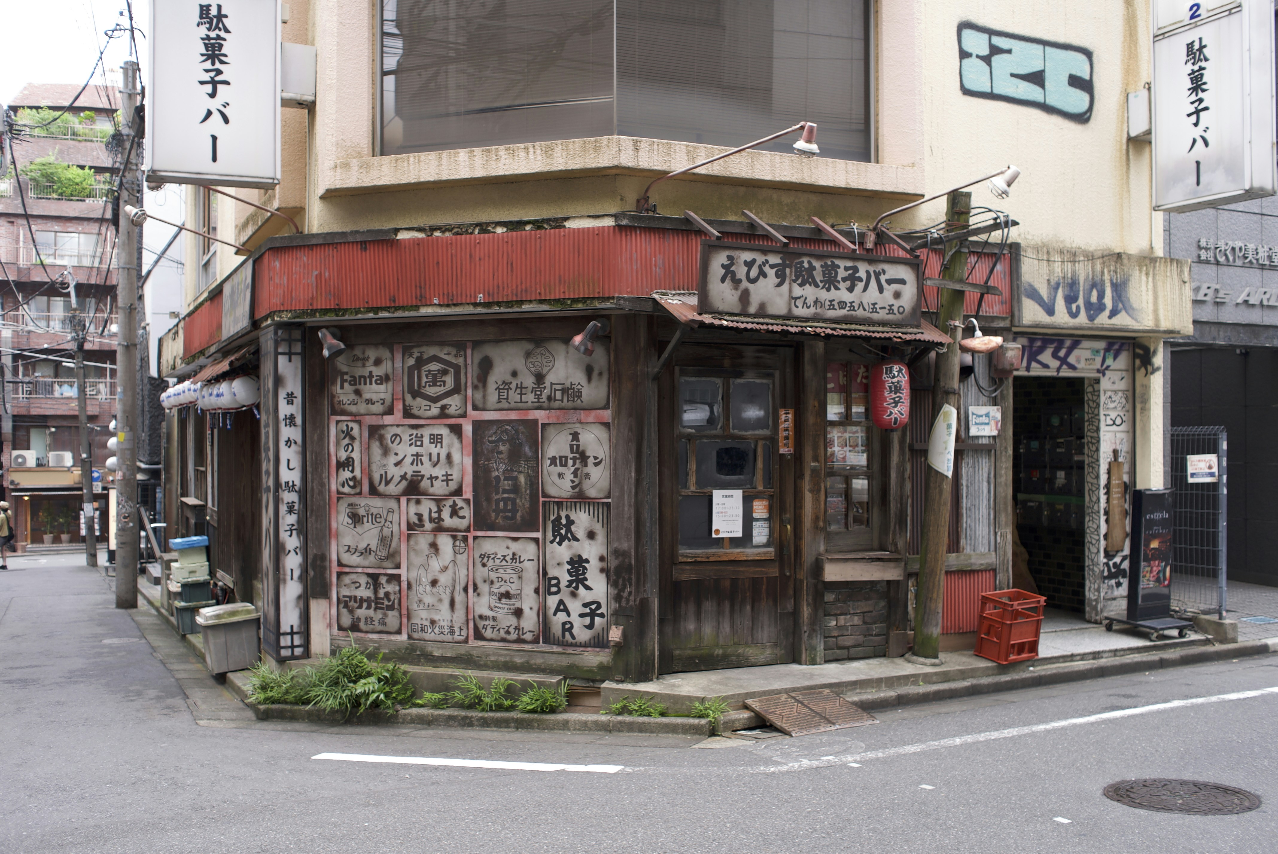 Old-Etched Facade: A Quiet Corner Store Tucked Between Signage