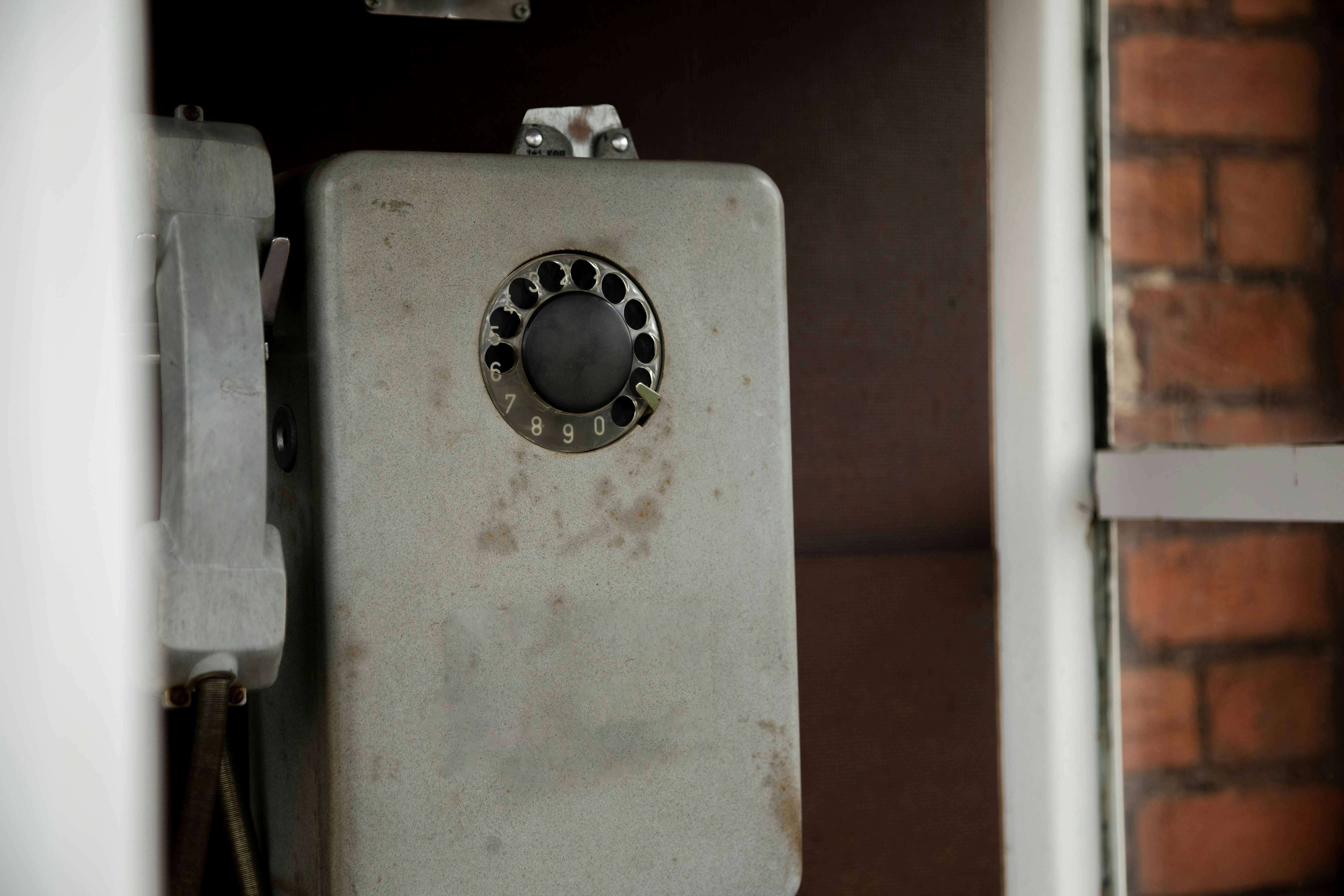 Rusty Dial in a Narrow Cabinet: A Quiet Portrait of Industrial Decay