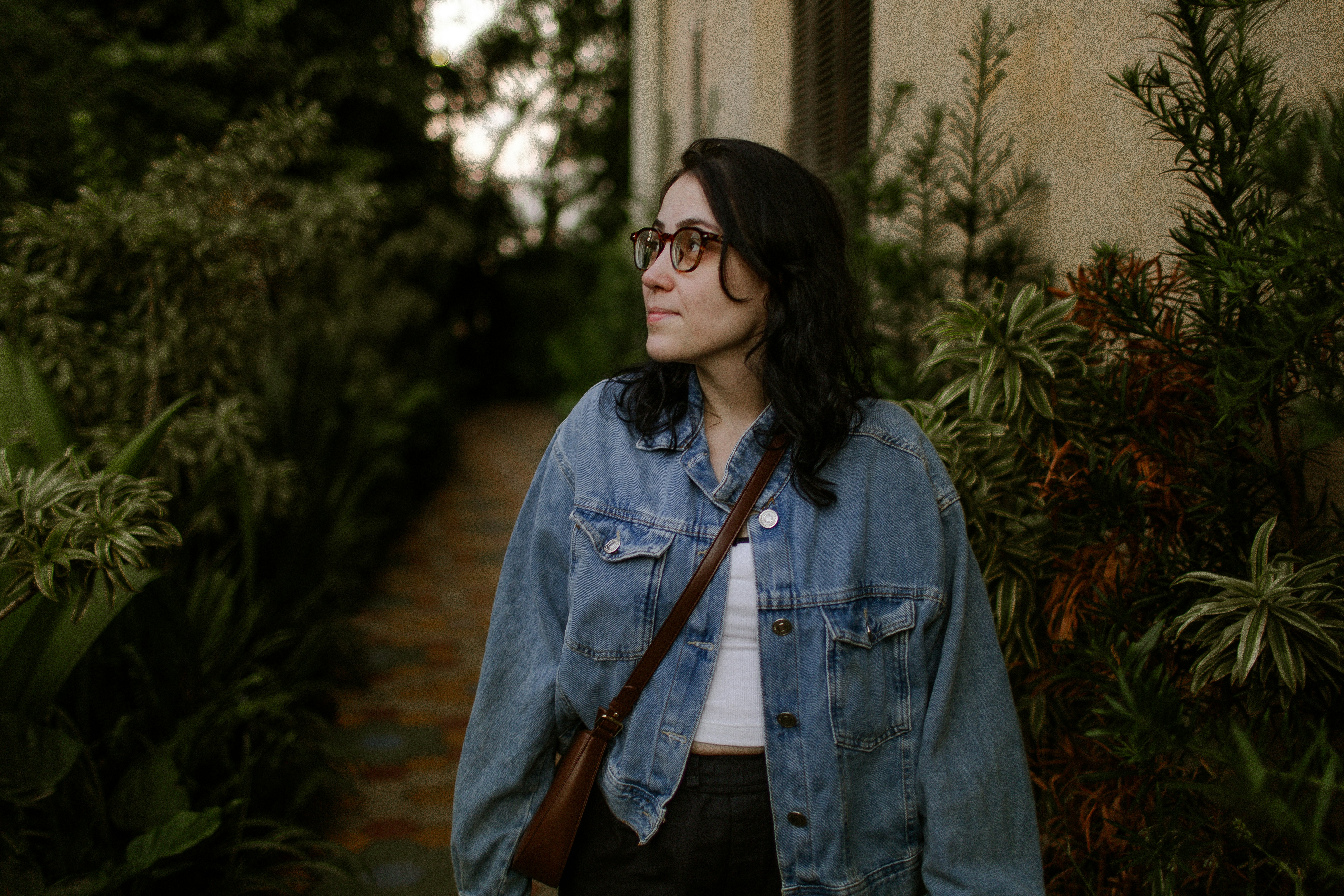 Denim Frame: A Casual Portrait in a Green Corridor