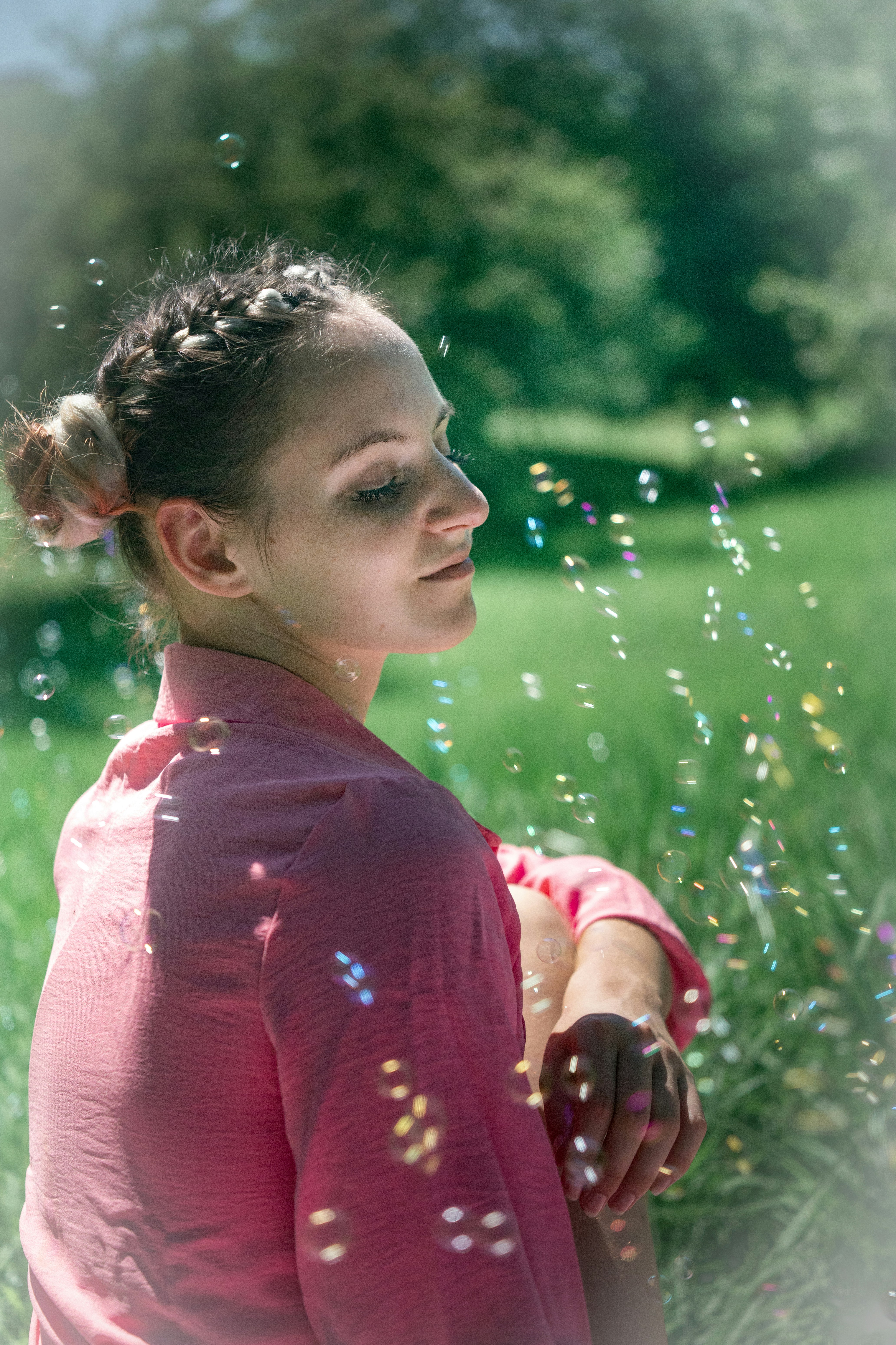 Bubbling Moments: a girl in a pink shirt amid sparkling jets of color