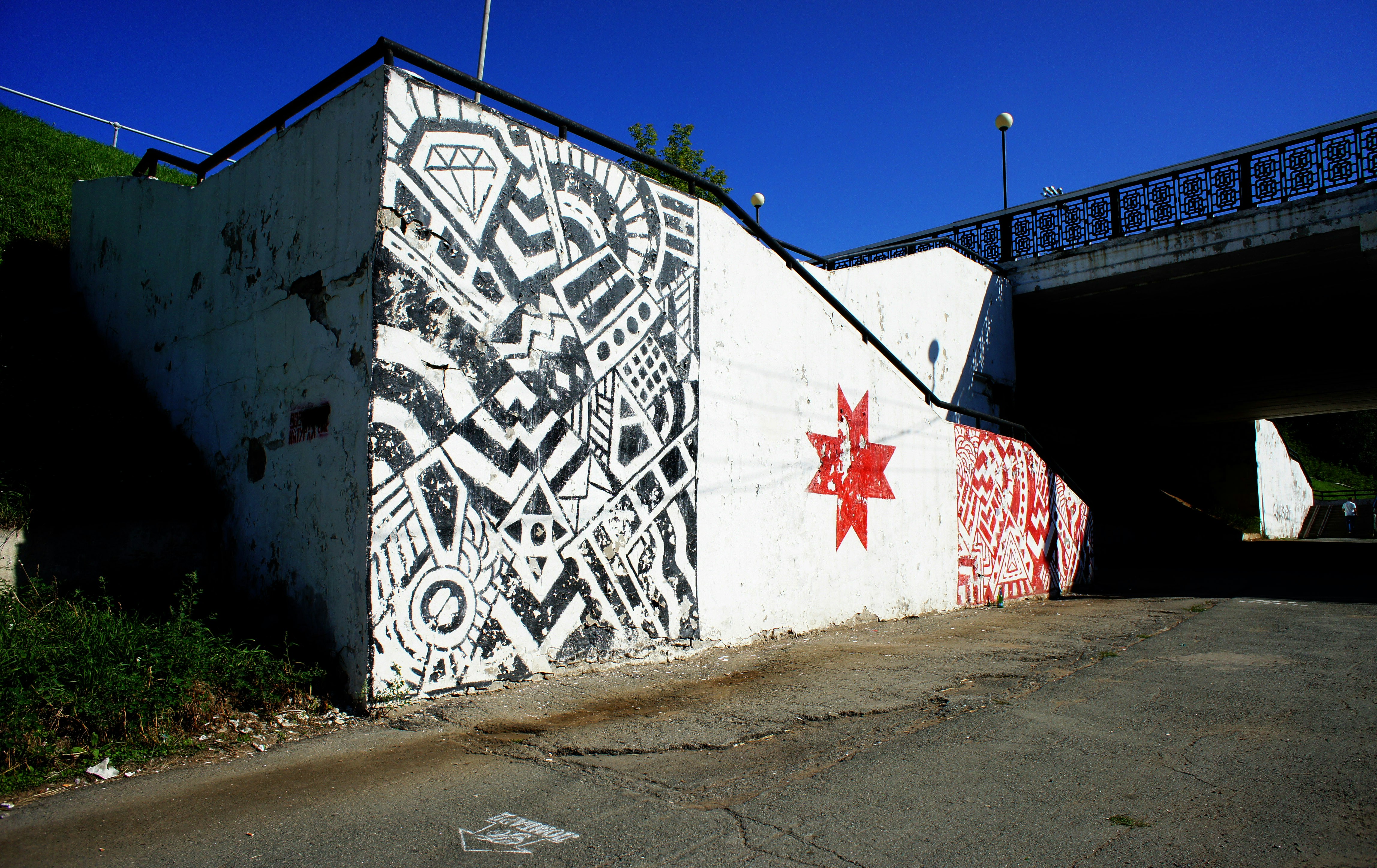 Geometric Graffiti on White Wall Underpass