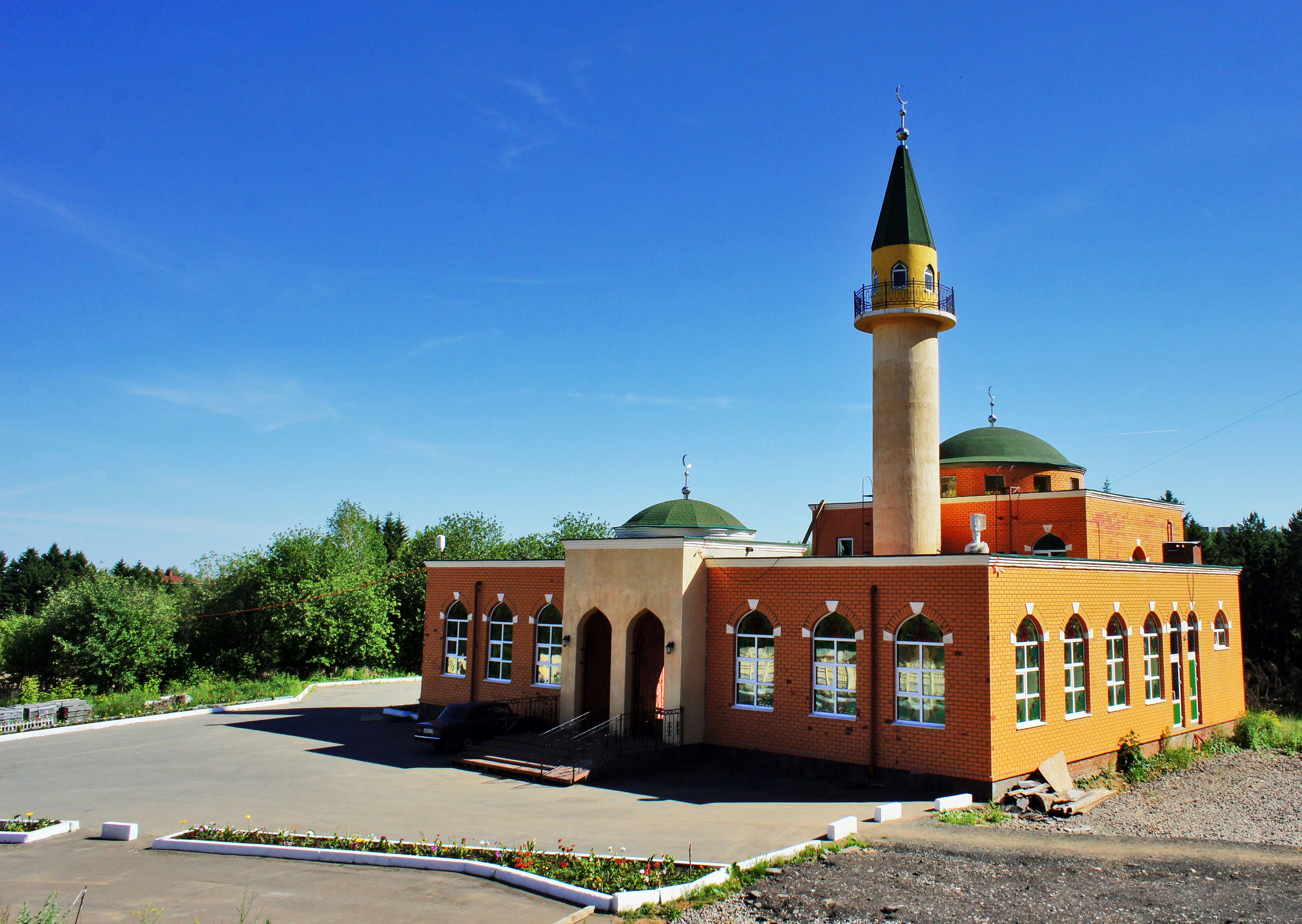 Cottage Mosque Afterlight: Sunlit brickdomes and minaret under a cobalt sky