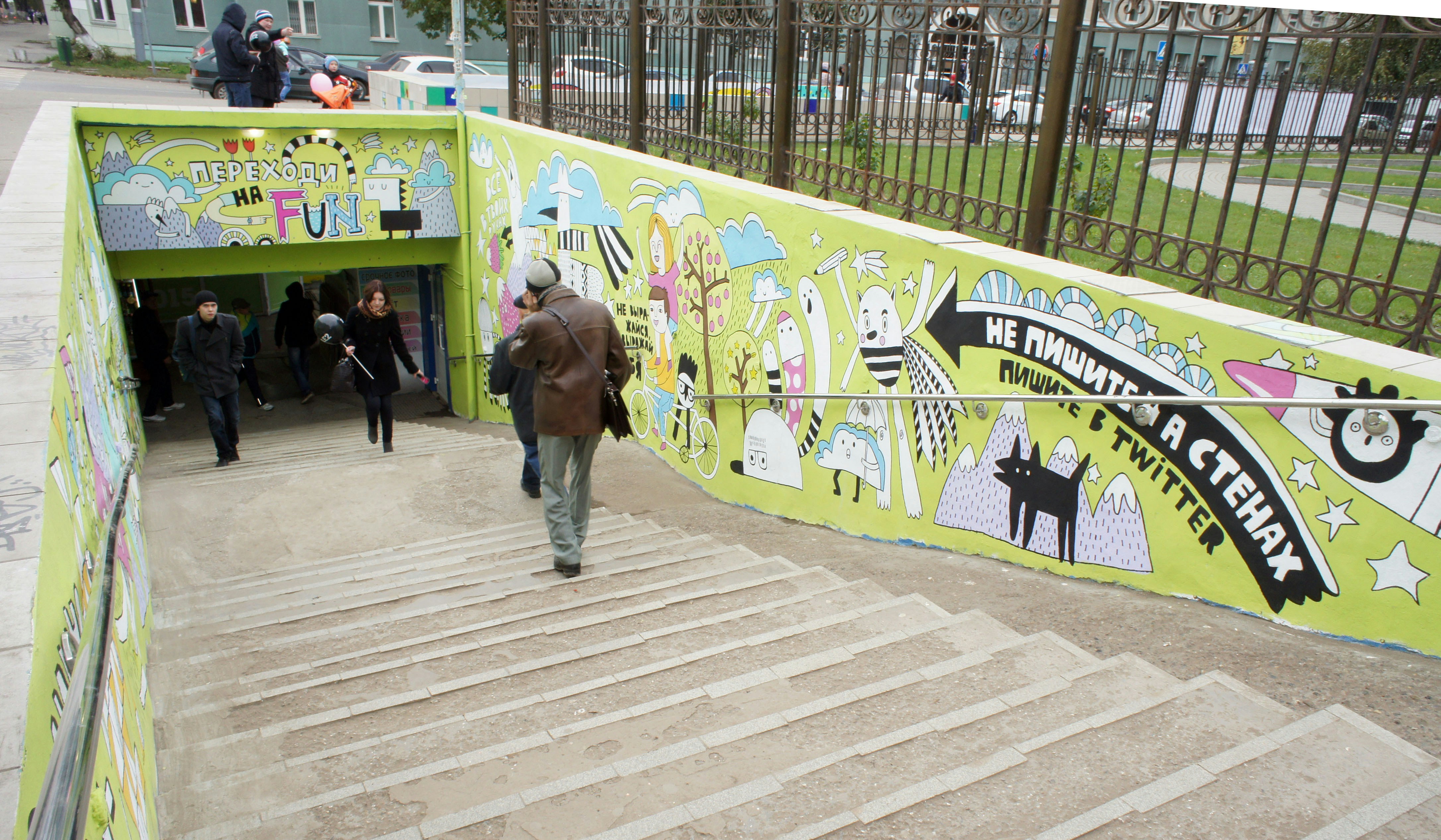 Underground Gallery: Colorful mural corridor anchors the stair descent