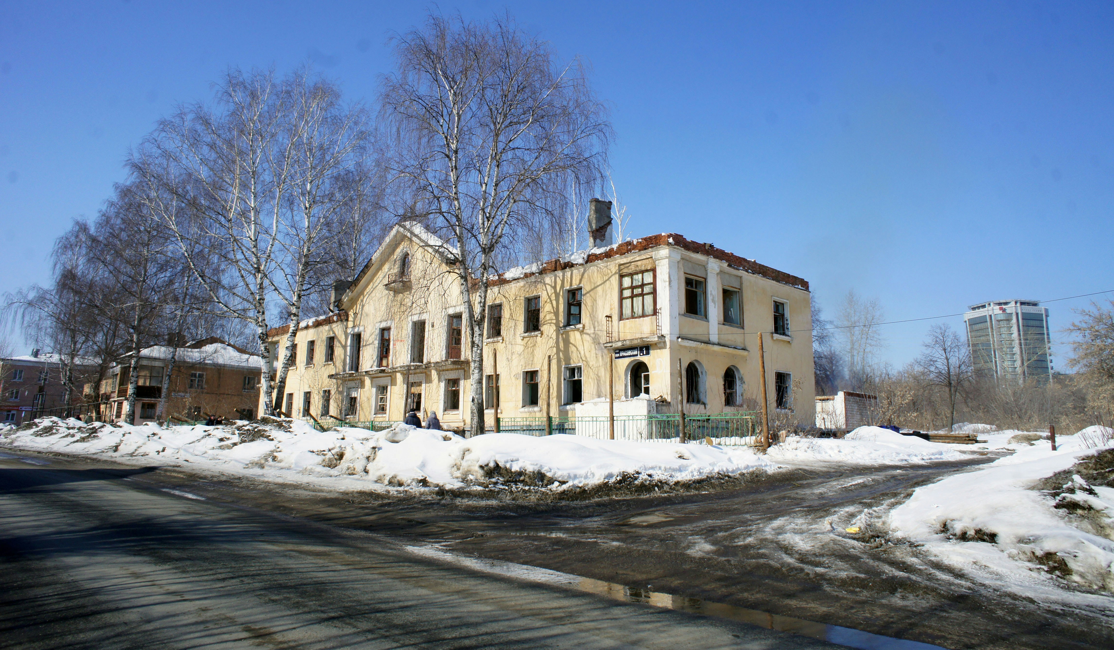 Abandoned brick mansion beneath a winter blue sky
