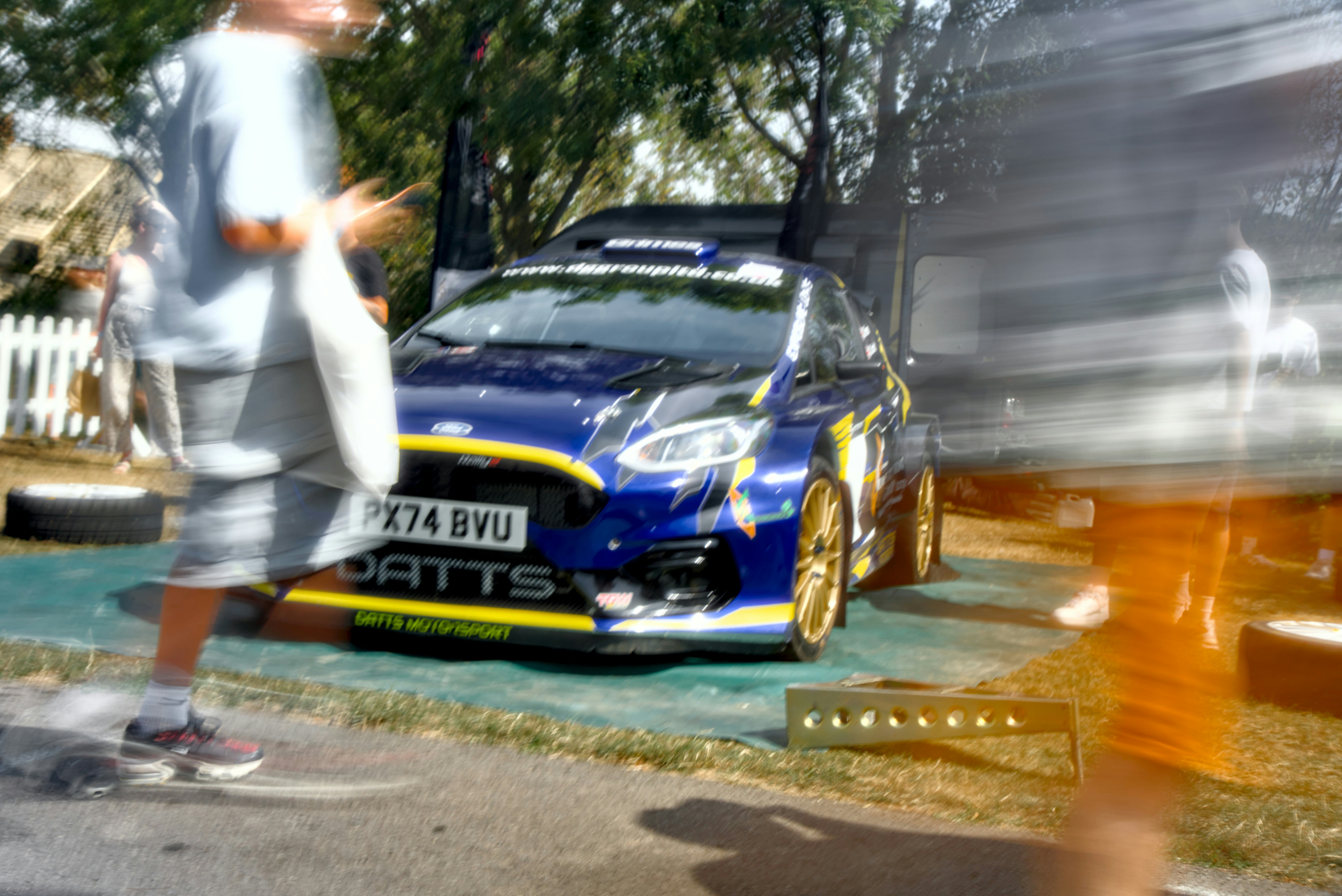 Blue Rally Car at a Motion-Blur Pit Stop