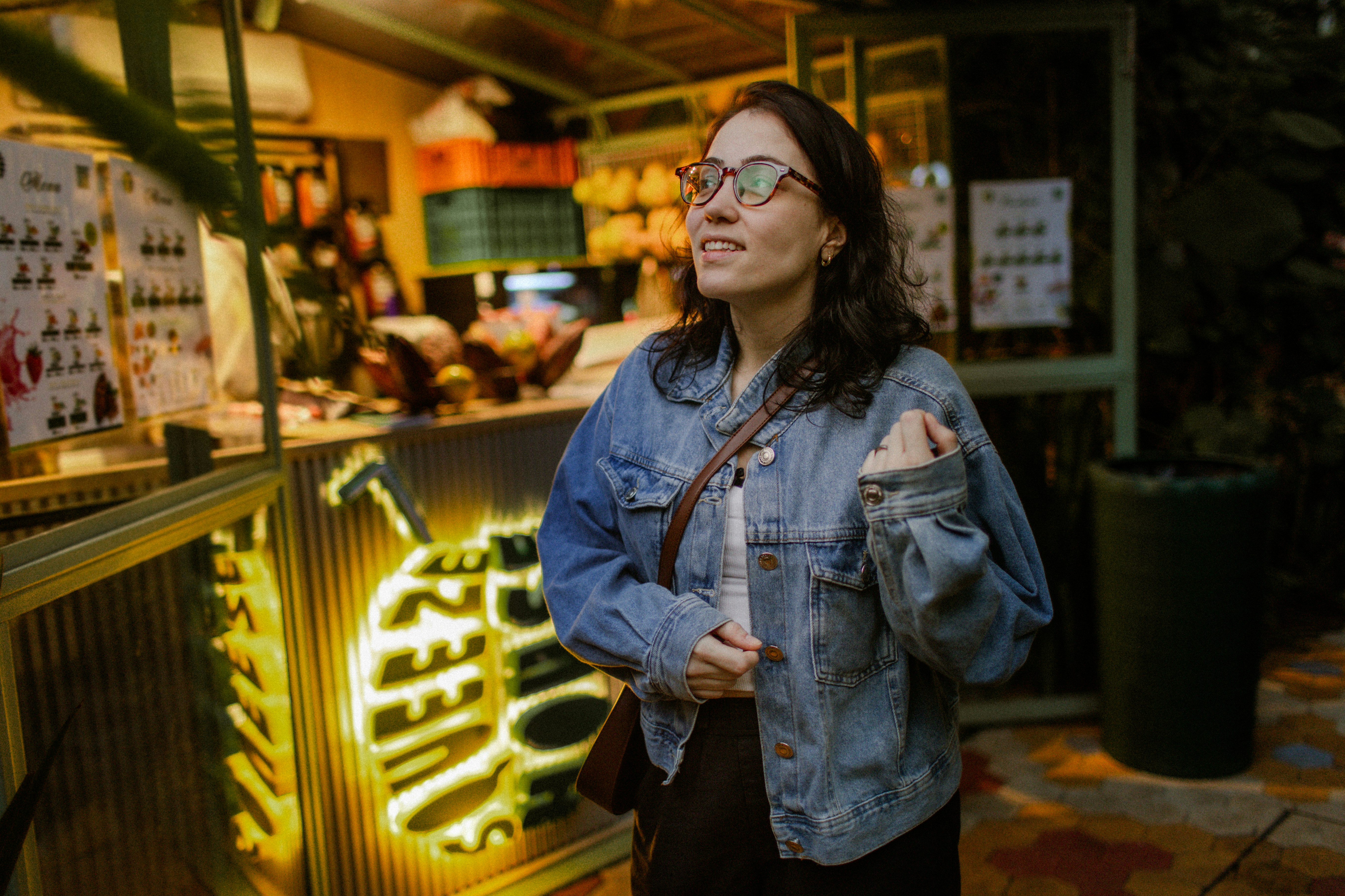 Denim glow: a street-food moment under warm market lights