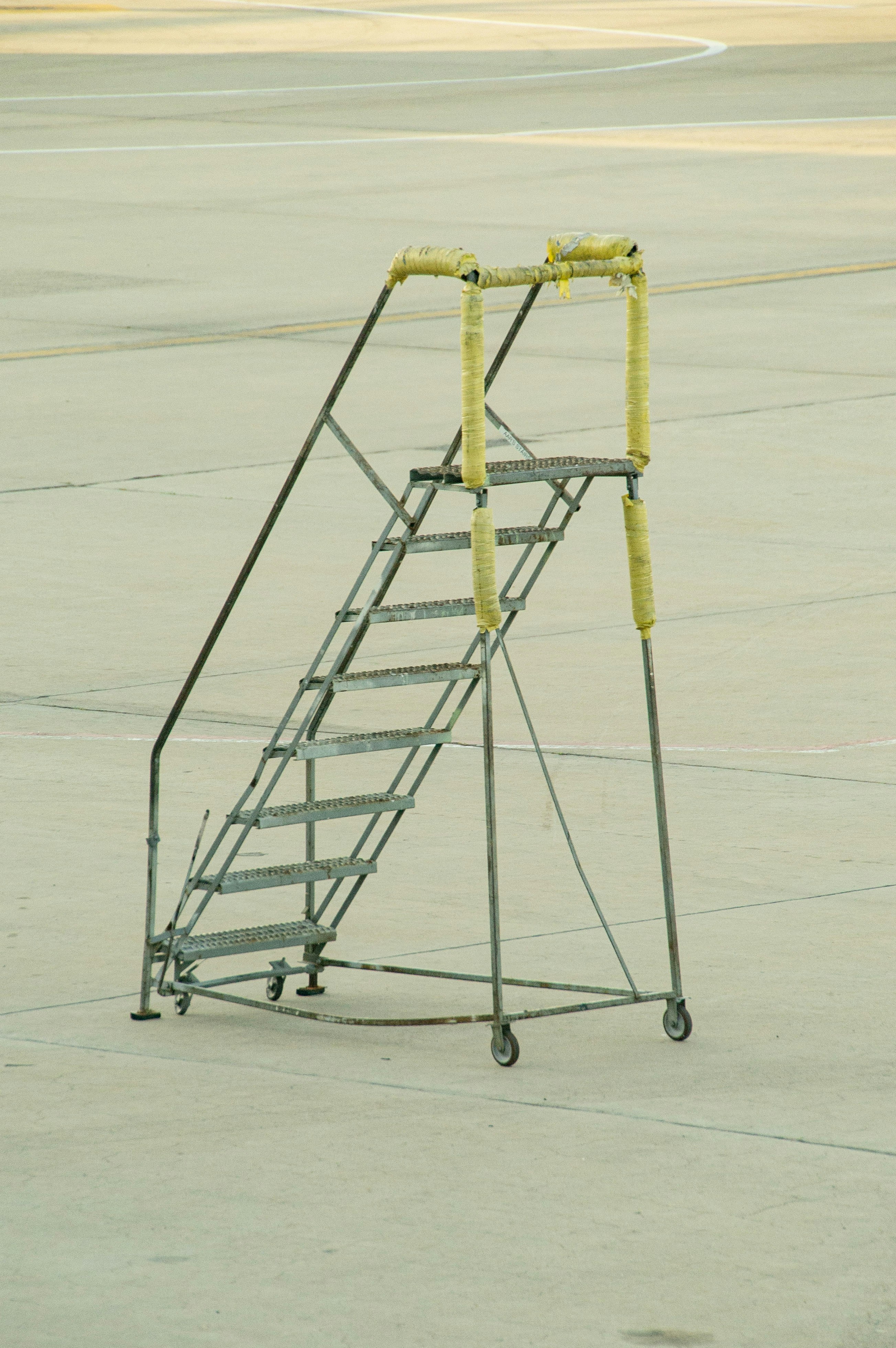 Weathered A-frame Stairway: Anisotropic Echo on a Sunlit Tarmac